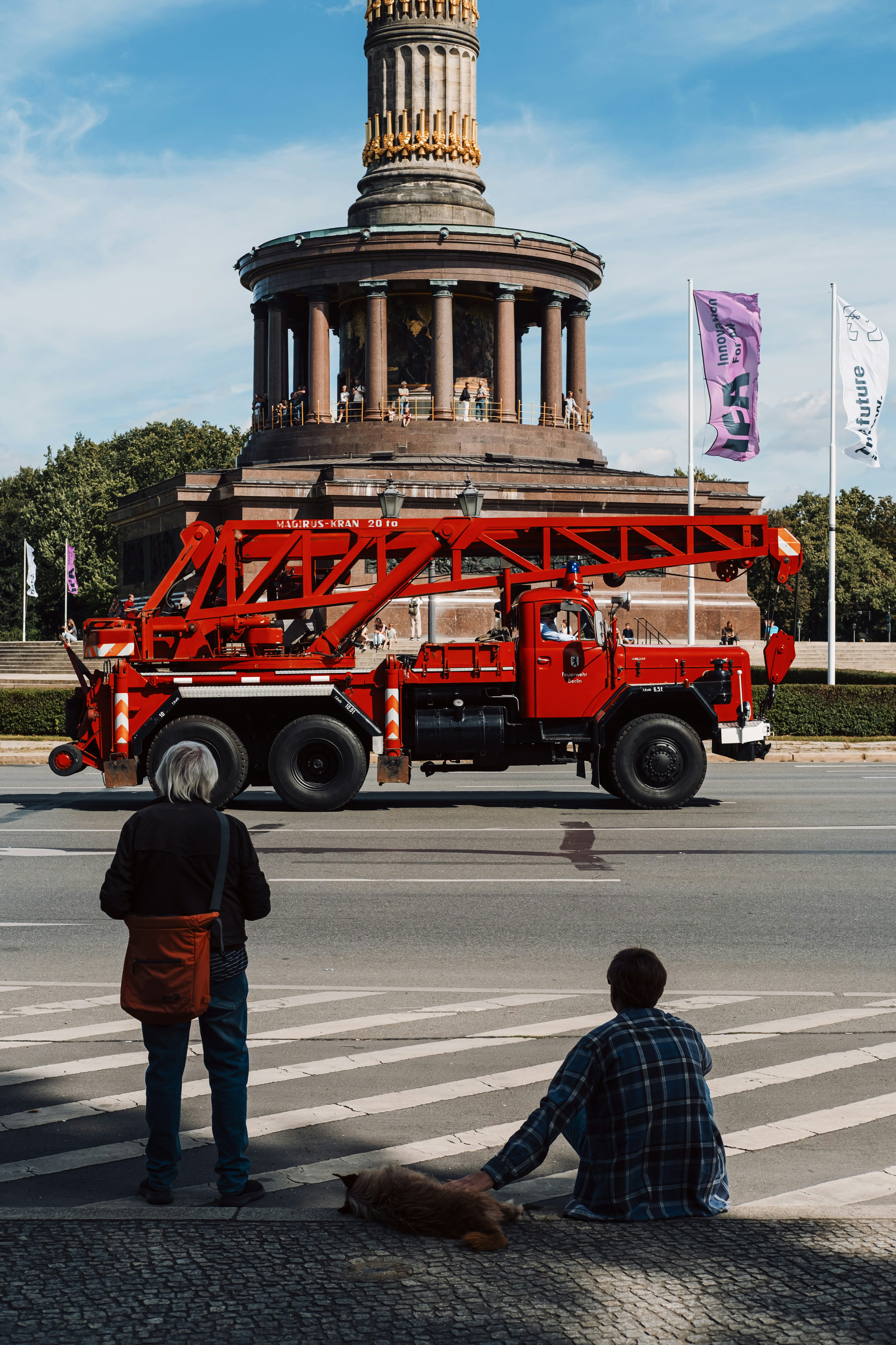 Red Fire Truck Pauses Before Monumental Columns