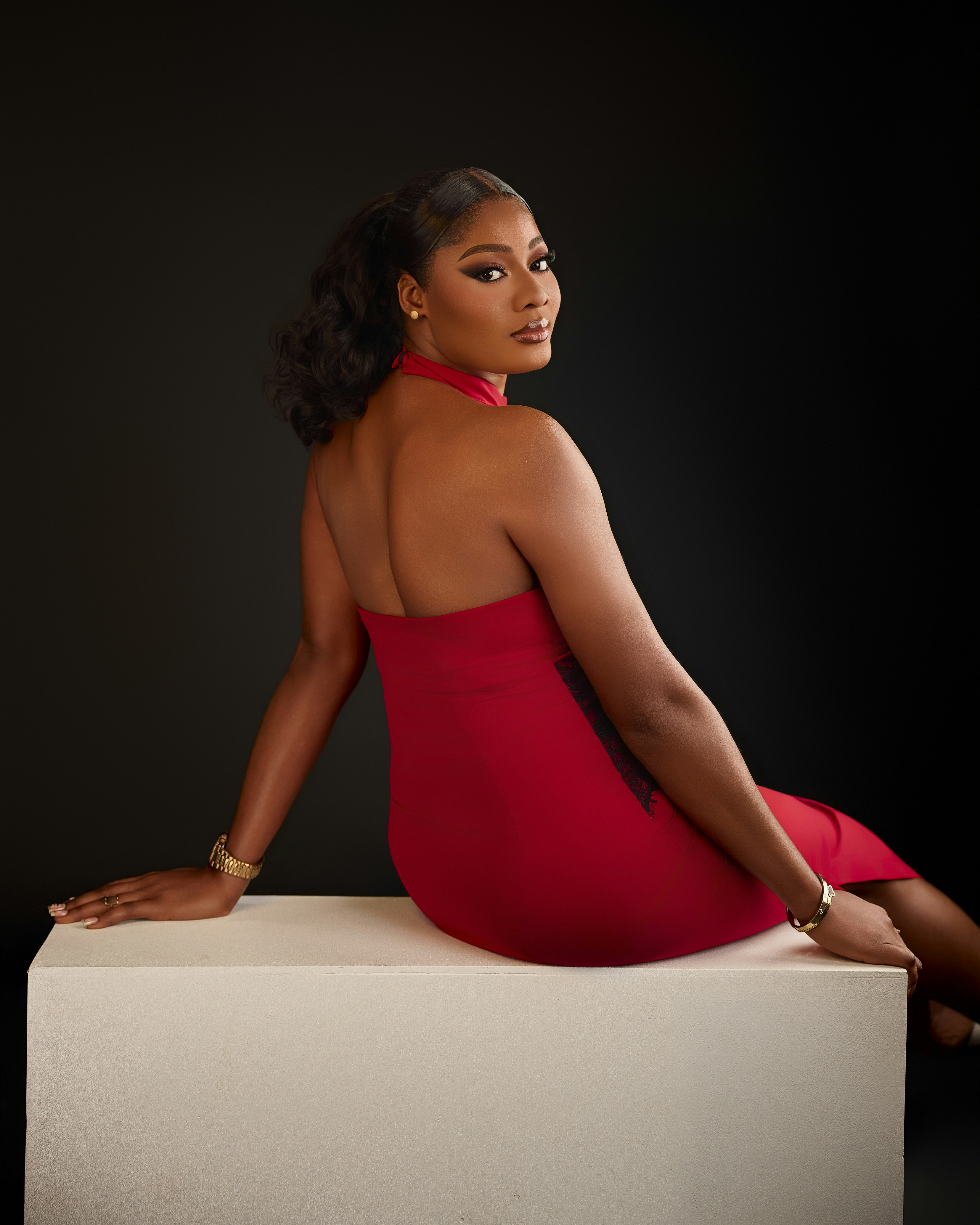 Red Dress, Dark Backdrop: Poised on the Edge of Light