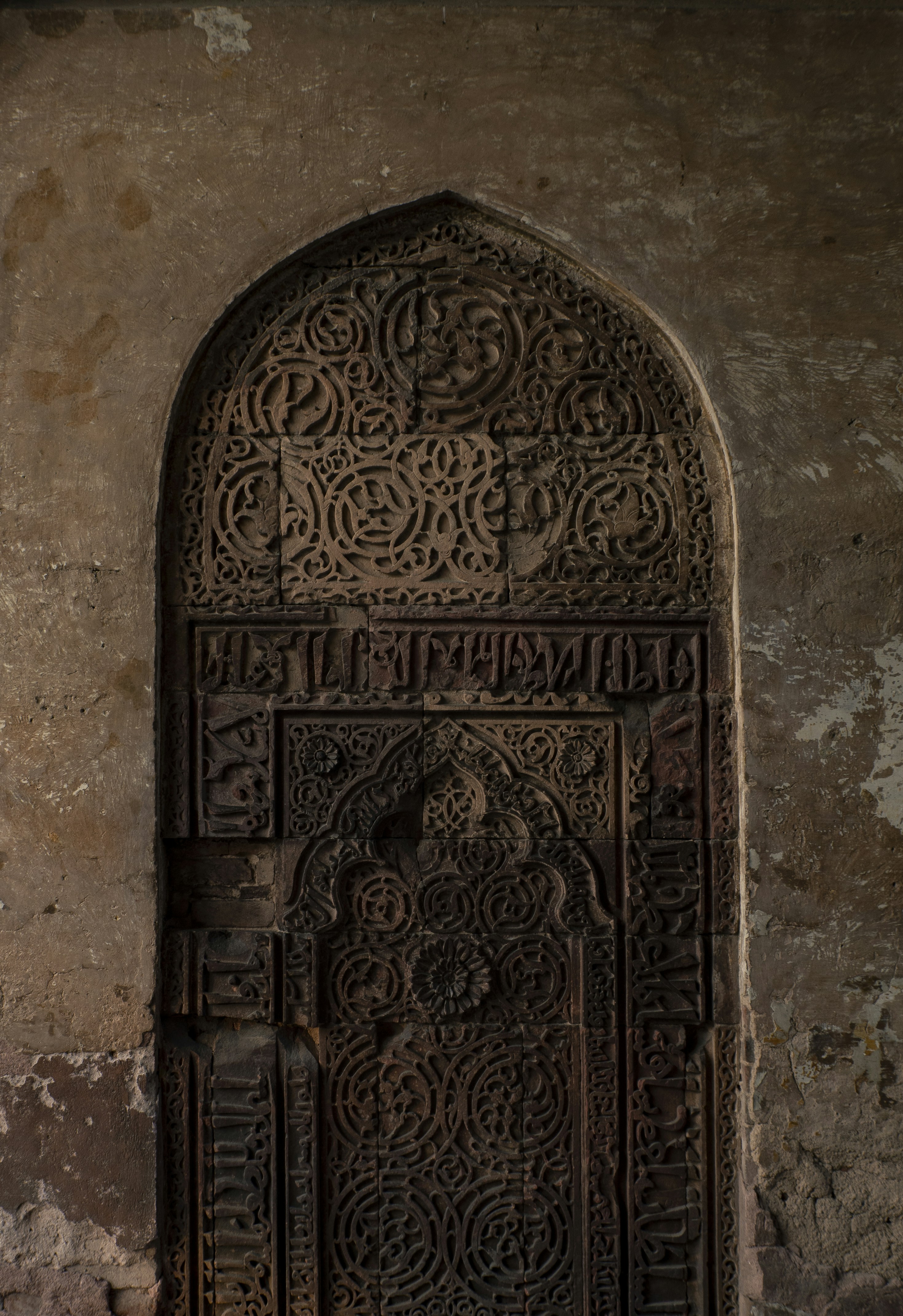 Carved Doorway of Time: An Ancient Archway with Floral Motifs