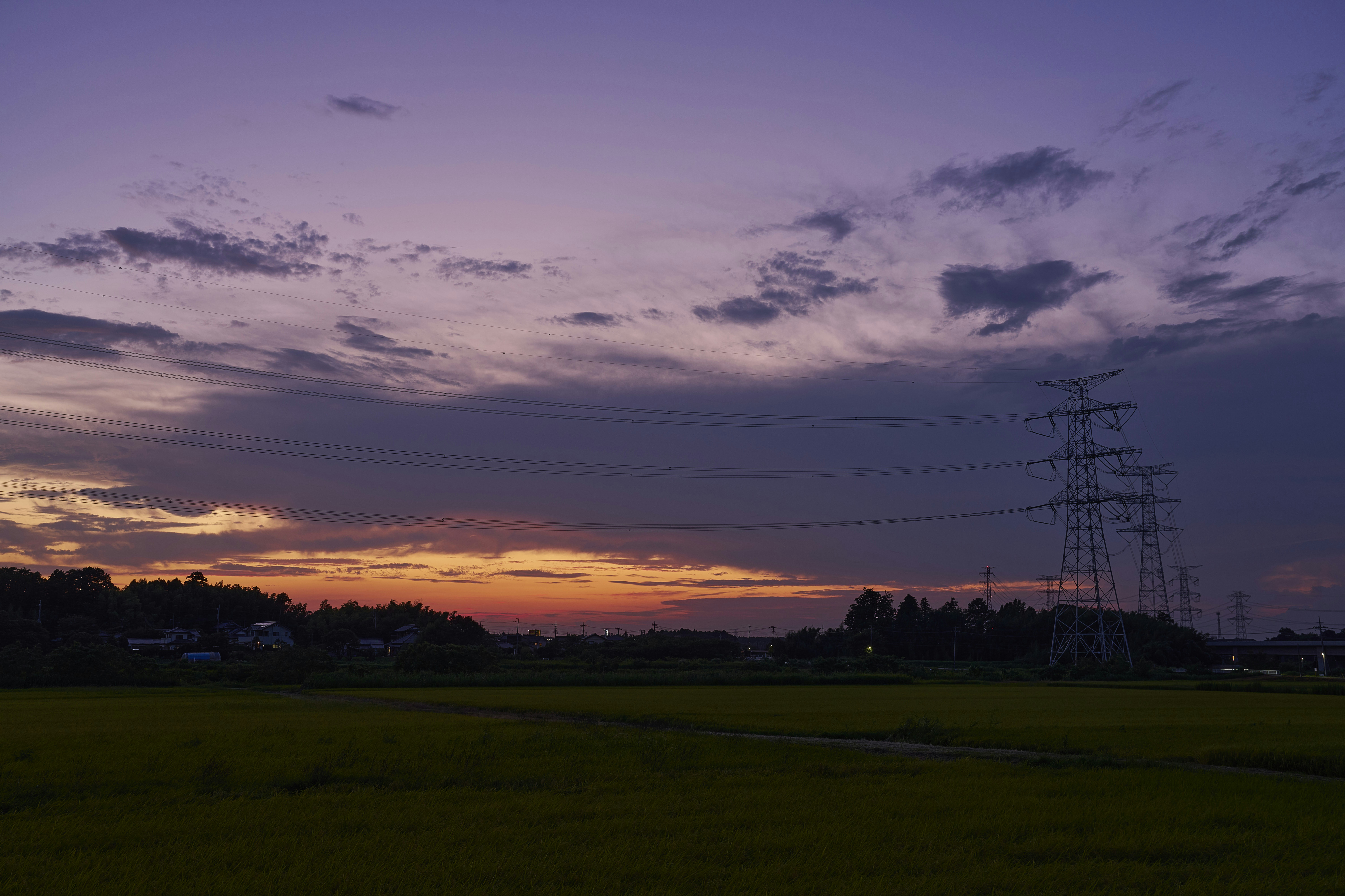 Dusk Over Quiet Fields Under a Looming Sky