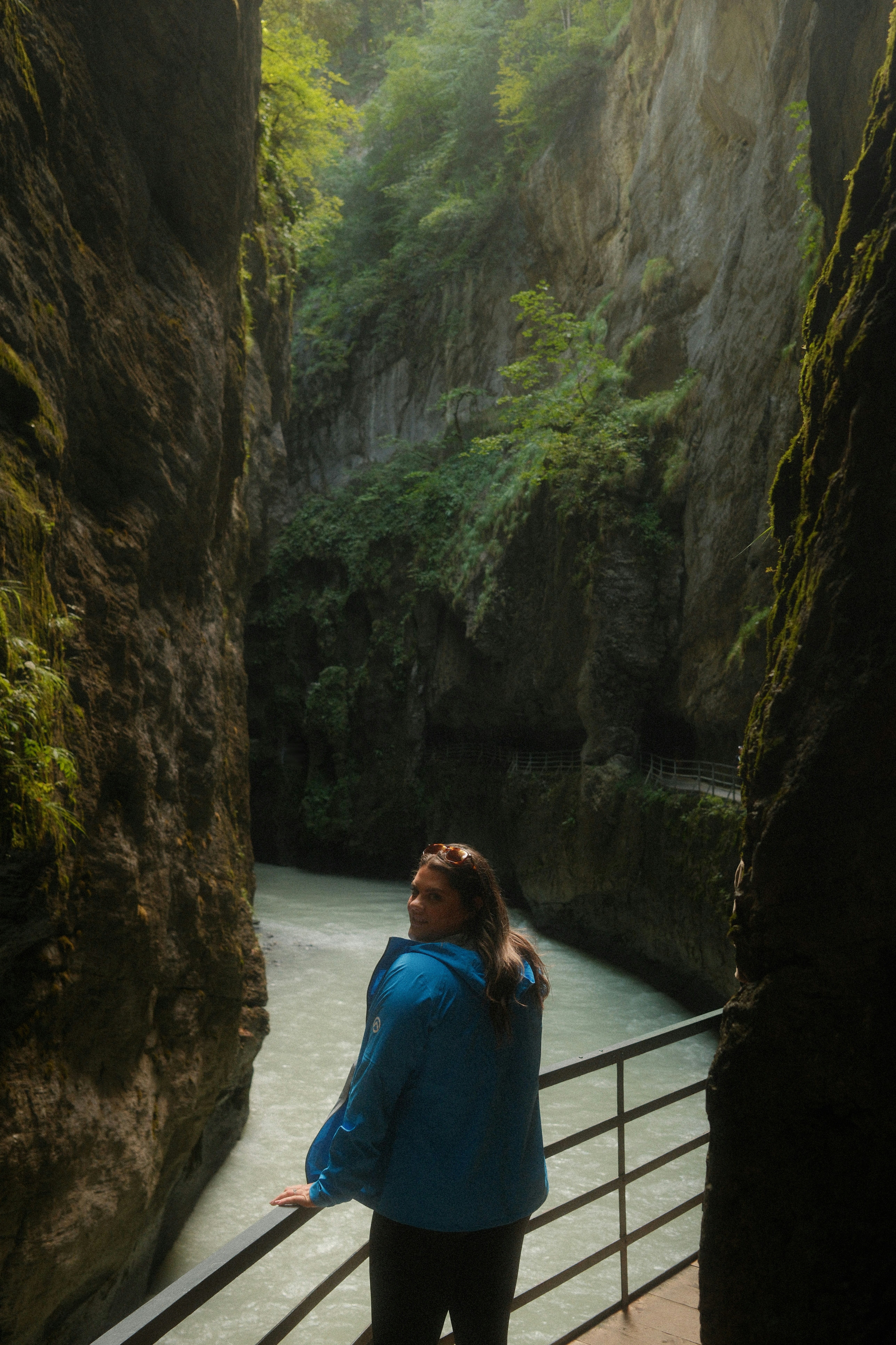 Blue-Jacketed Wanderer Amidst Narrow Canyon Gorge
