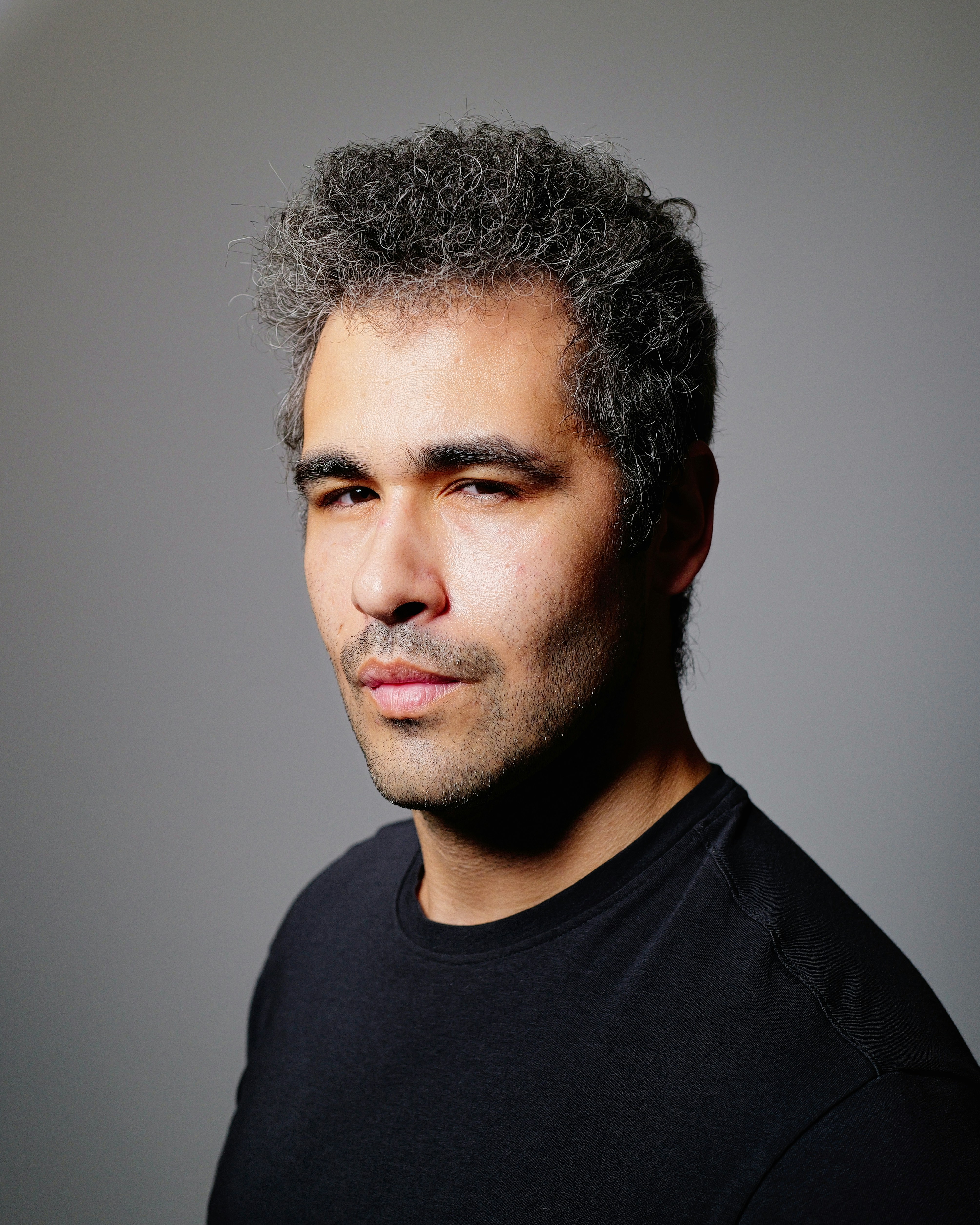 Confidence in Focus: A Studio Portrait with Subtle Edge