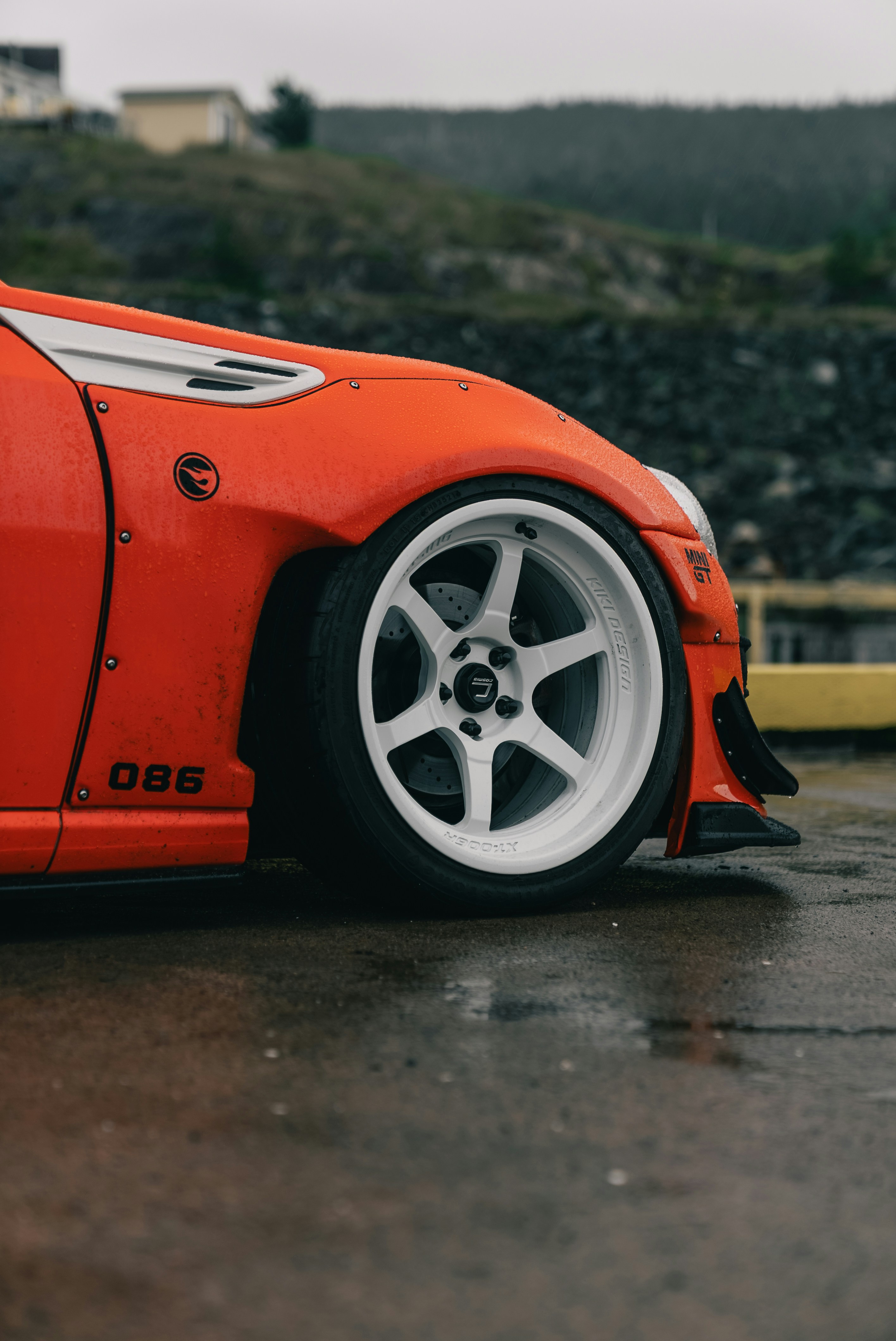 Racing Orange: Close-Up of a Wide Finned Wheel and Body Details