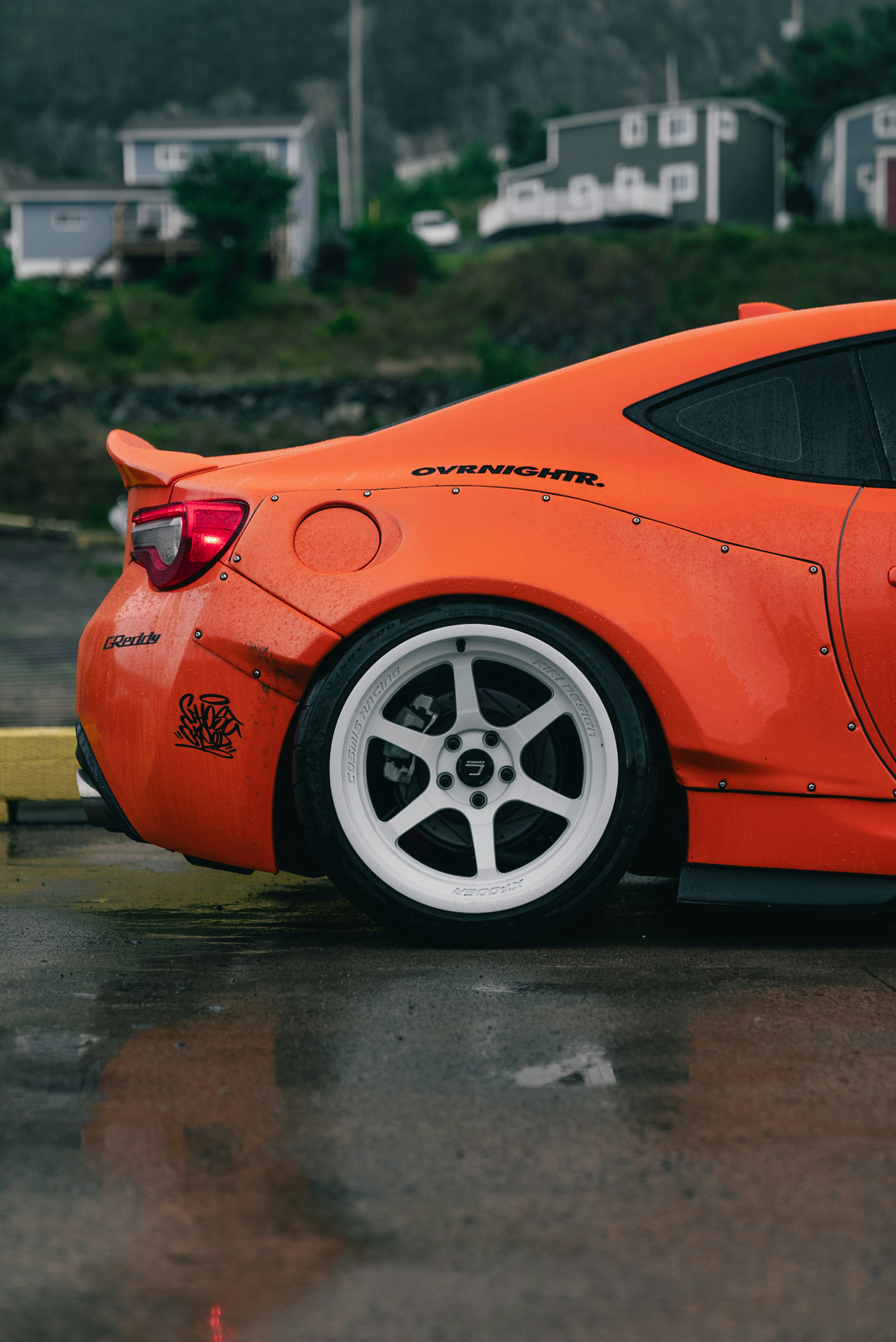 Orange Rotary: The Stout Rear Quarter of a Modified Sports Car