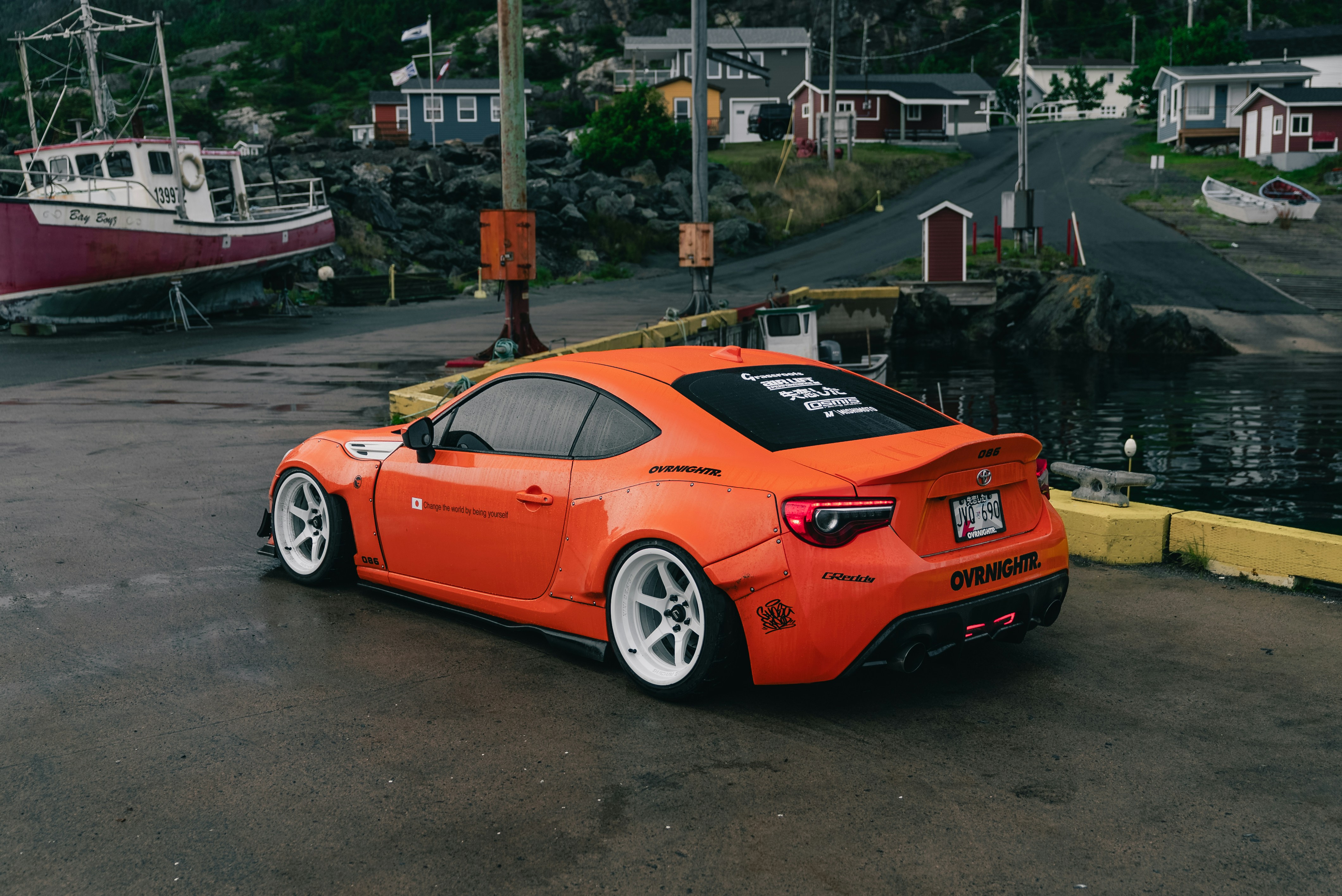 Vivid Orange Drift: Low-slung cruiser at a quiet harbor