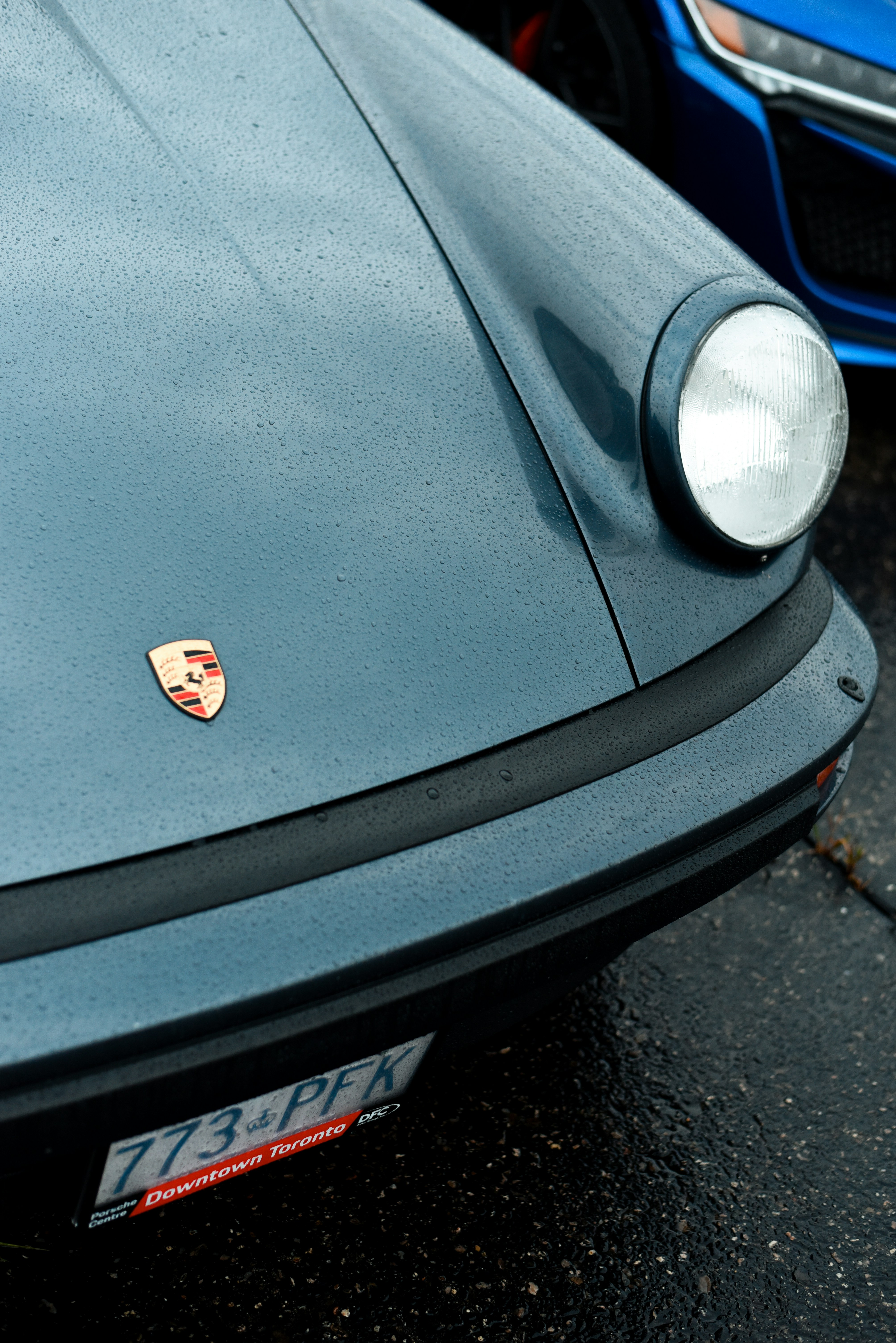 Blue Porsche Hoodie: A Close-Up of Rain-Soft Curves and Badge