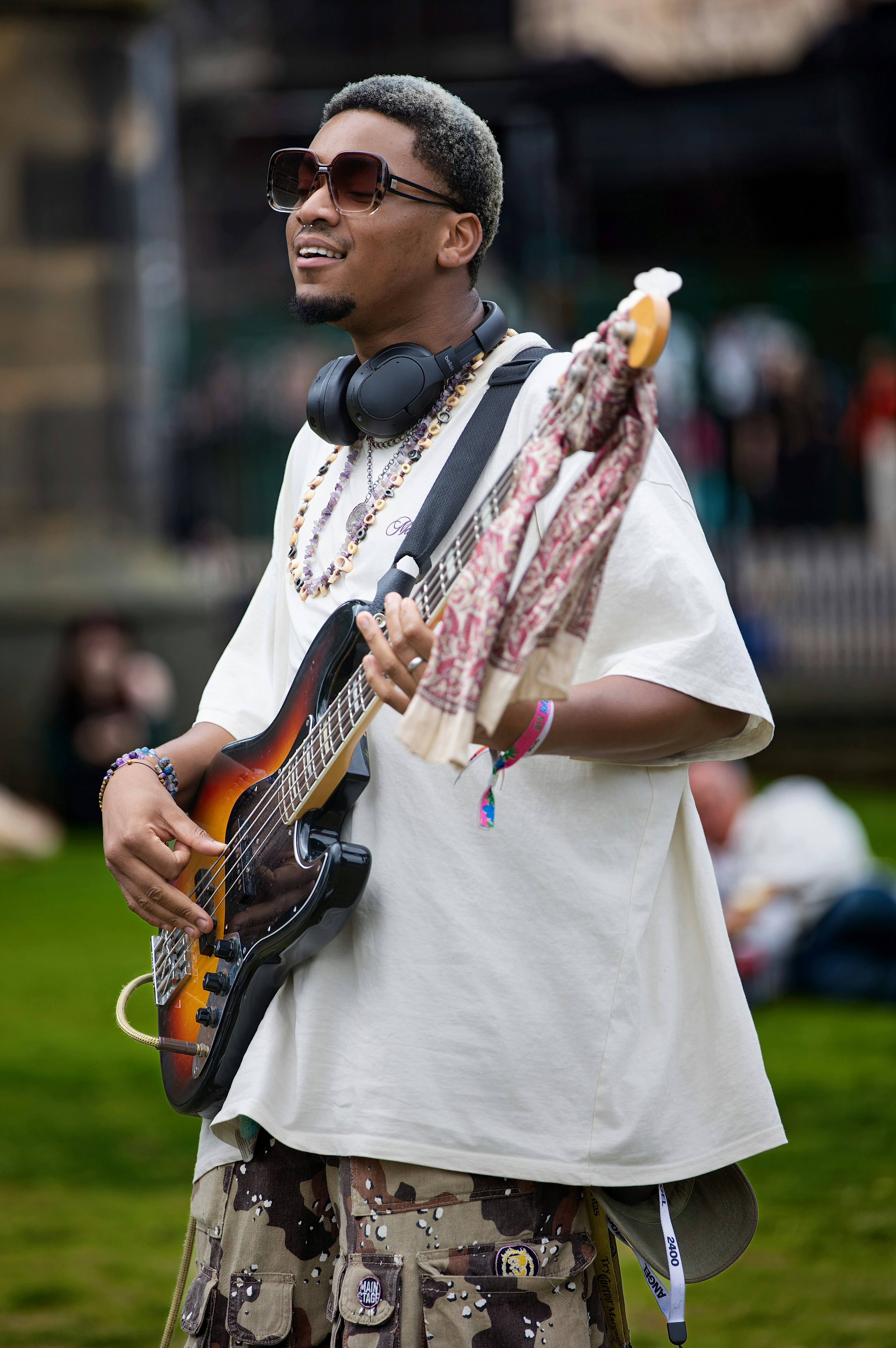 Sunlit Groove: Bassist in a White Tee with Beside-Song Scarf