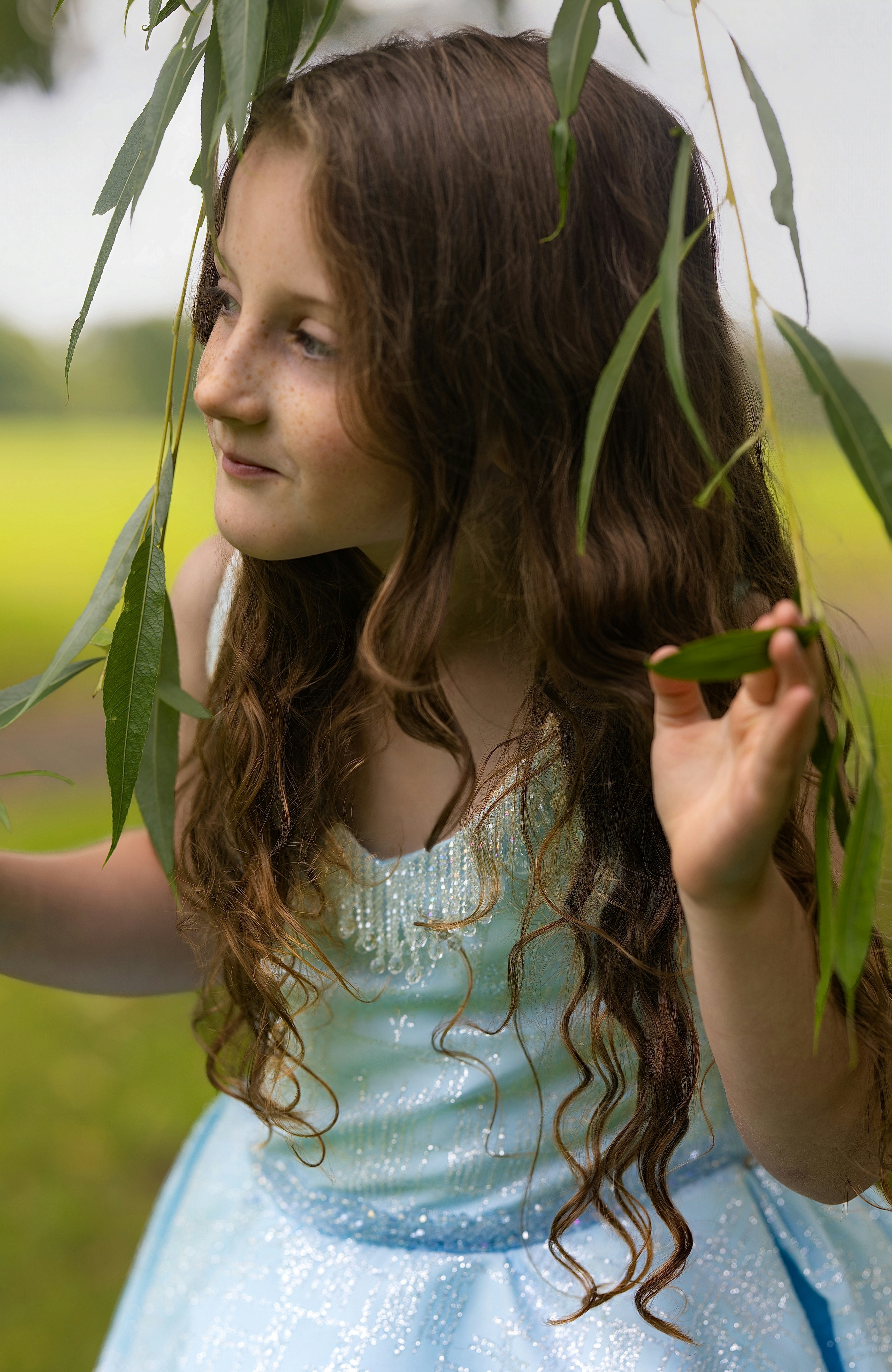 Portrait in a Leaf Frame: a girl in a pale blue dress gazes softly off to the side