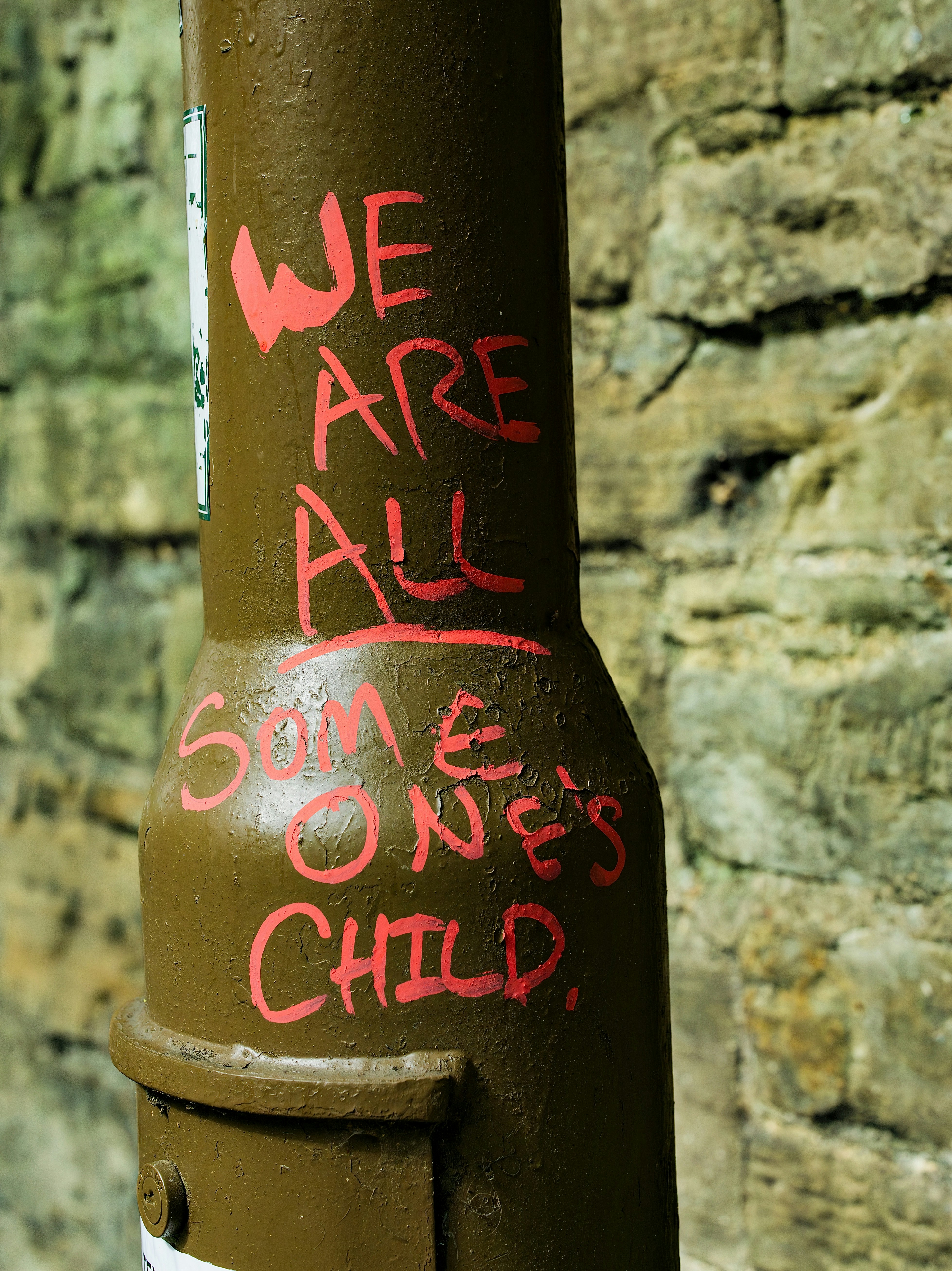 We Are All Someones Child: Graffiti on a Rusty Pipe