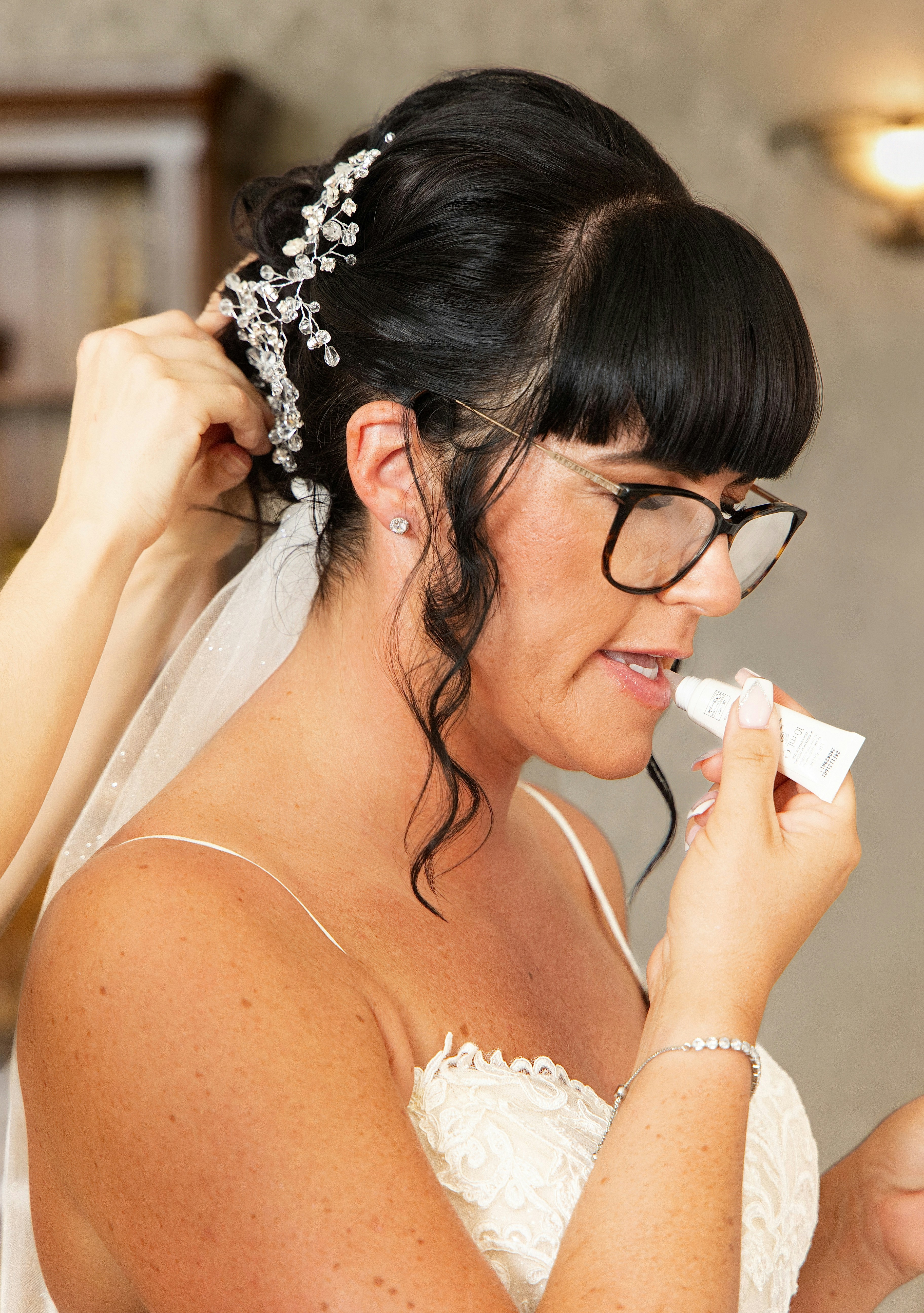 Bride in Glasses Finishing Touch: Lipgloss and Lace