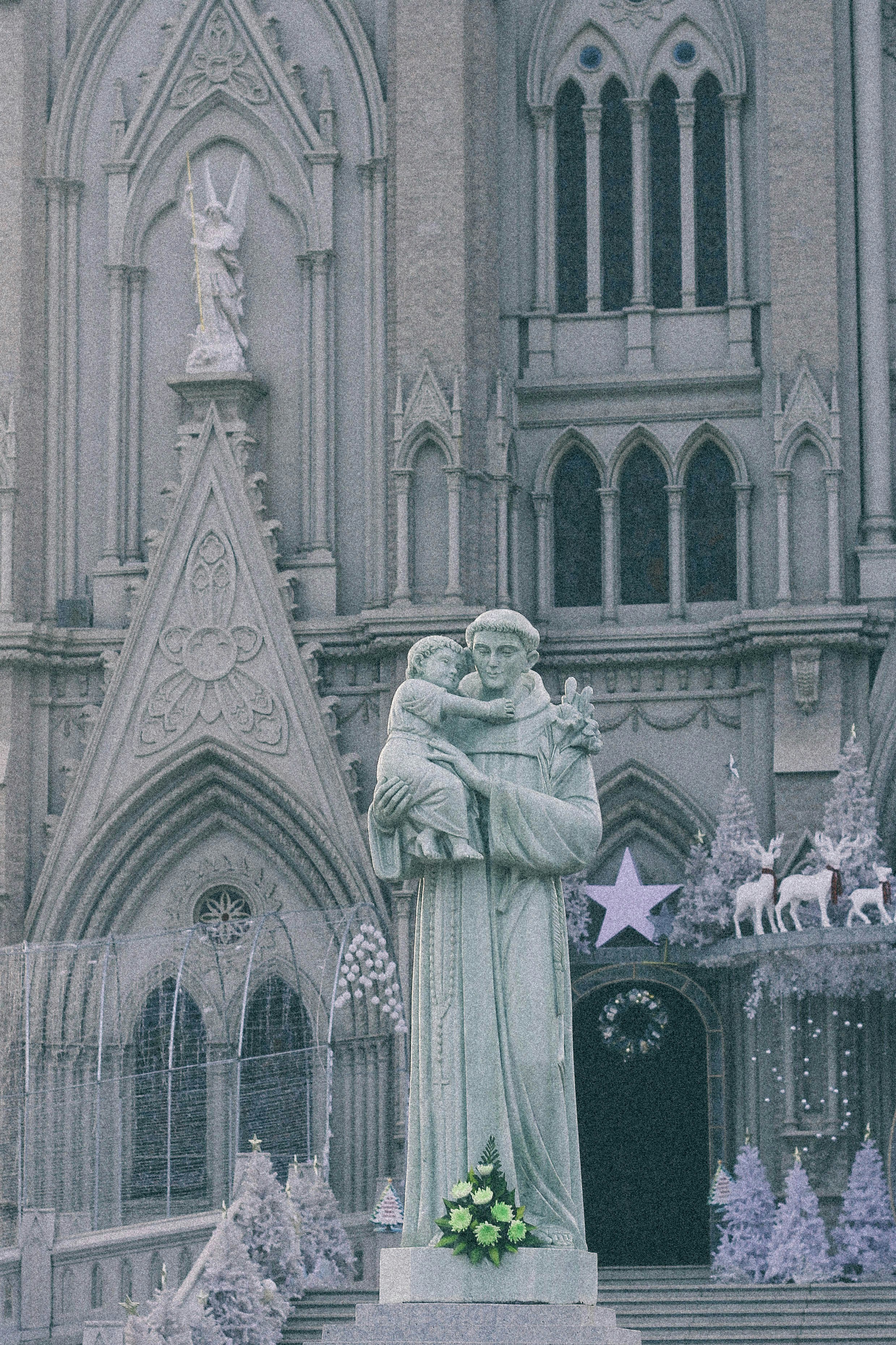 Statue of Saintly Embrace in a Gothic Cathedral Courtyard