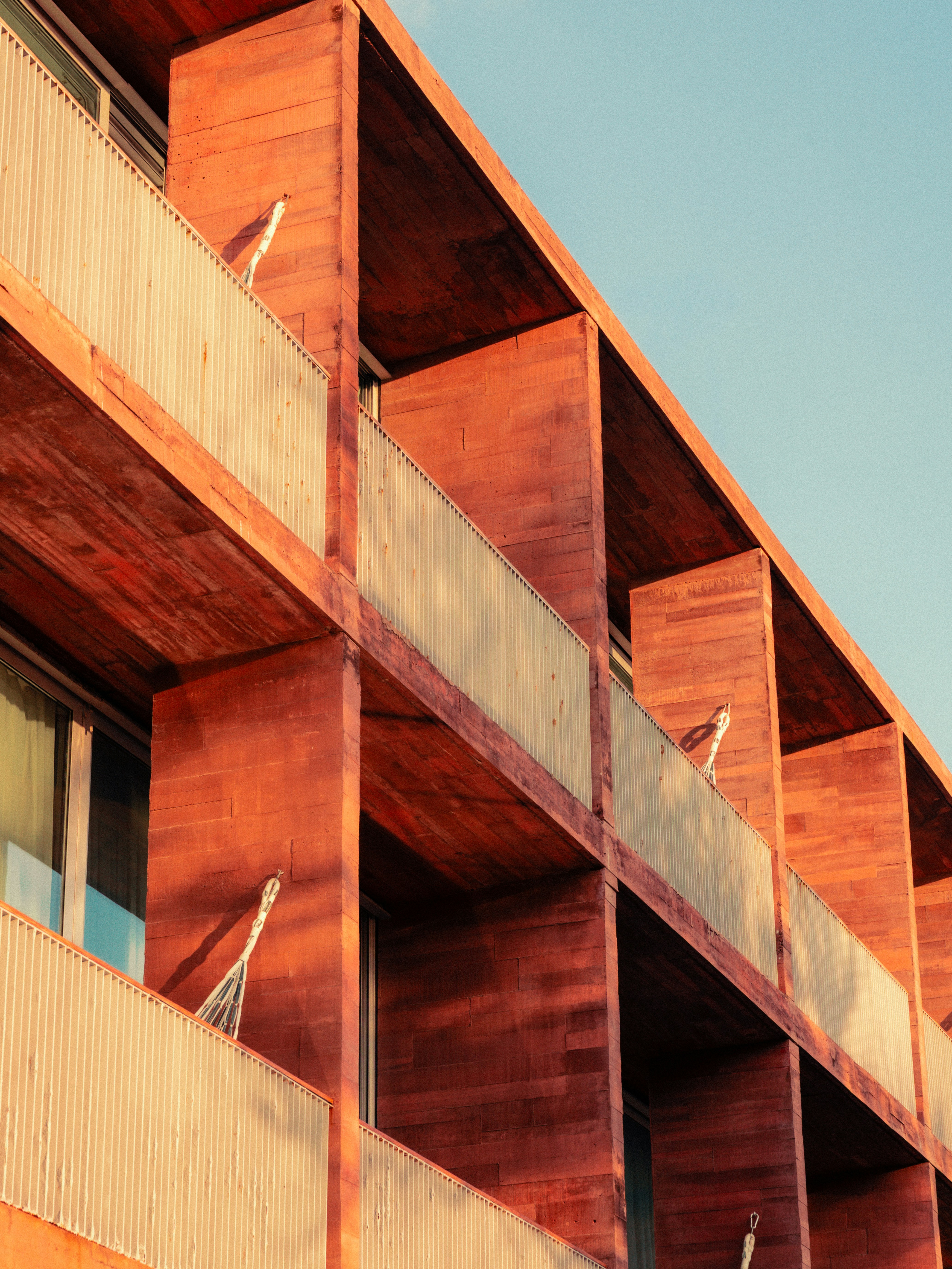 Concrete Ridges in Rust: A Sunset on Modern Balconies
