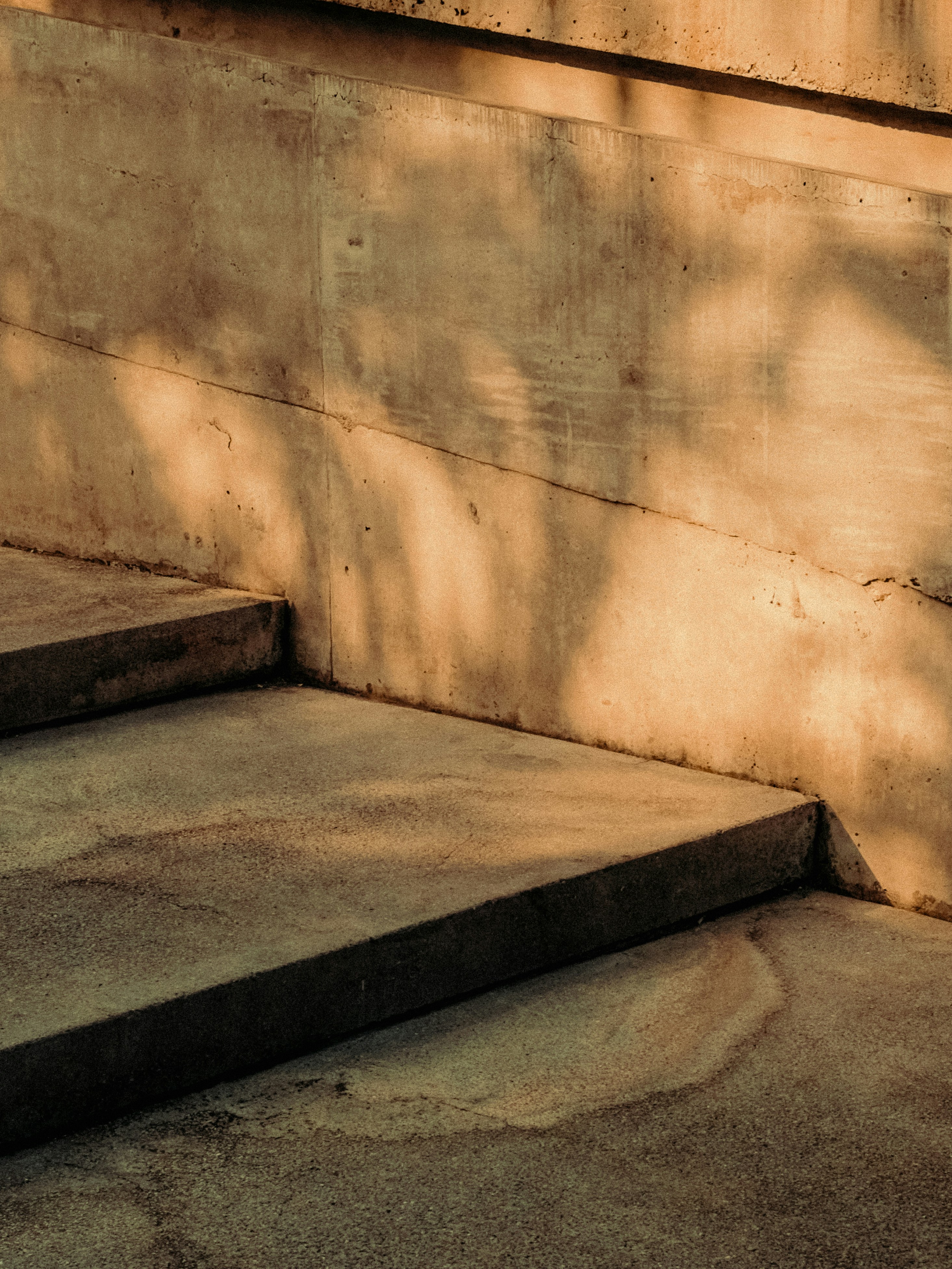 Sunlit Concrete Steps and Shadowed Wall