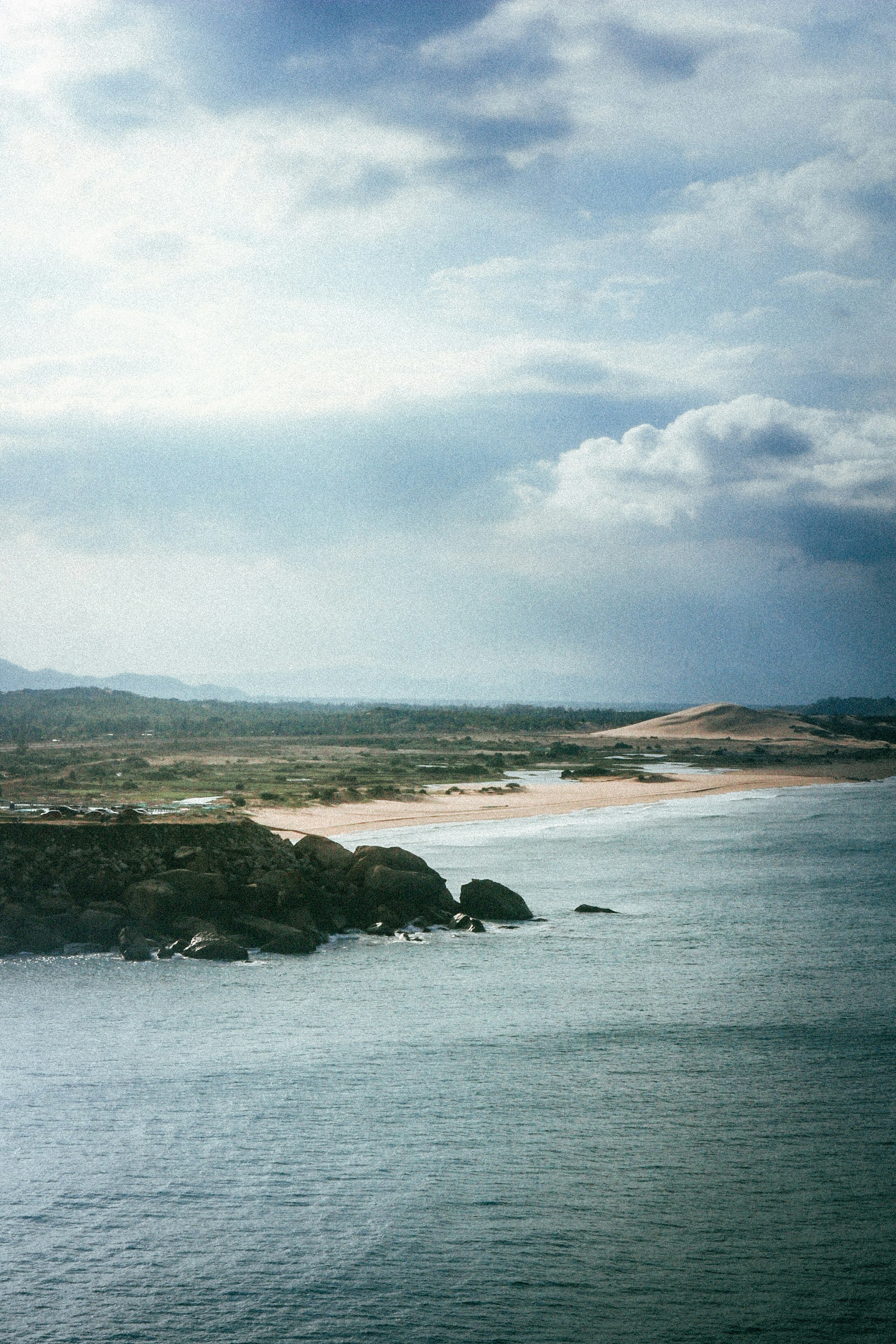 Coastal Quiet: Dunes, Rock Outcrops, and a Shifting Sea Horizon