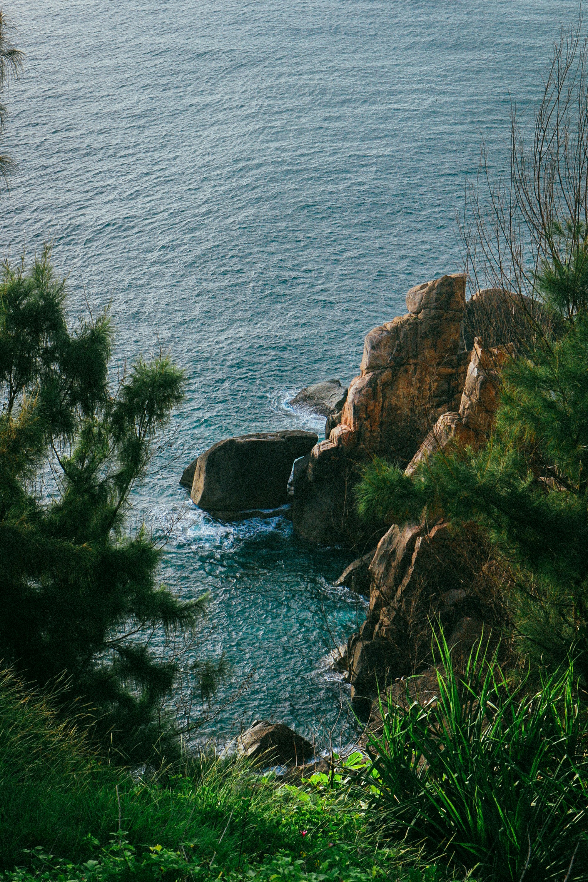 Cliffside Cove: Blue Water Meets Sunlit Rocks