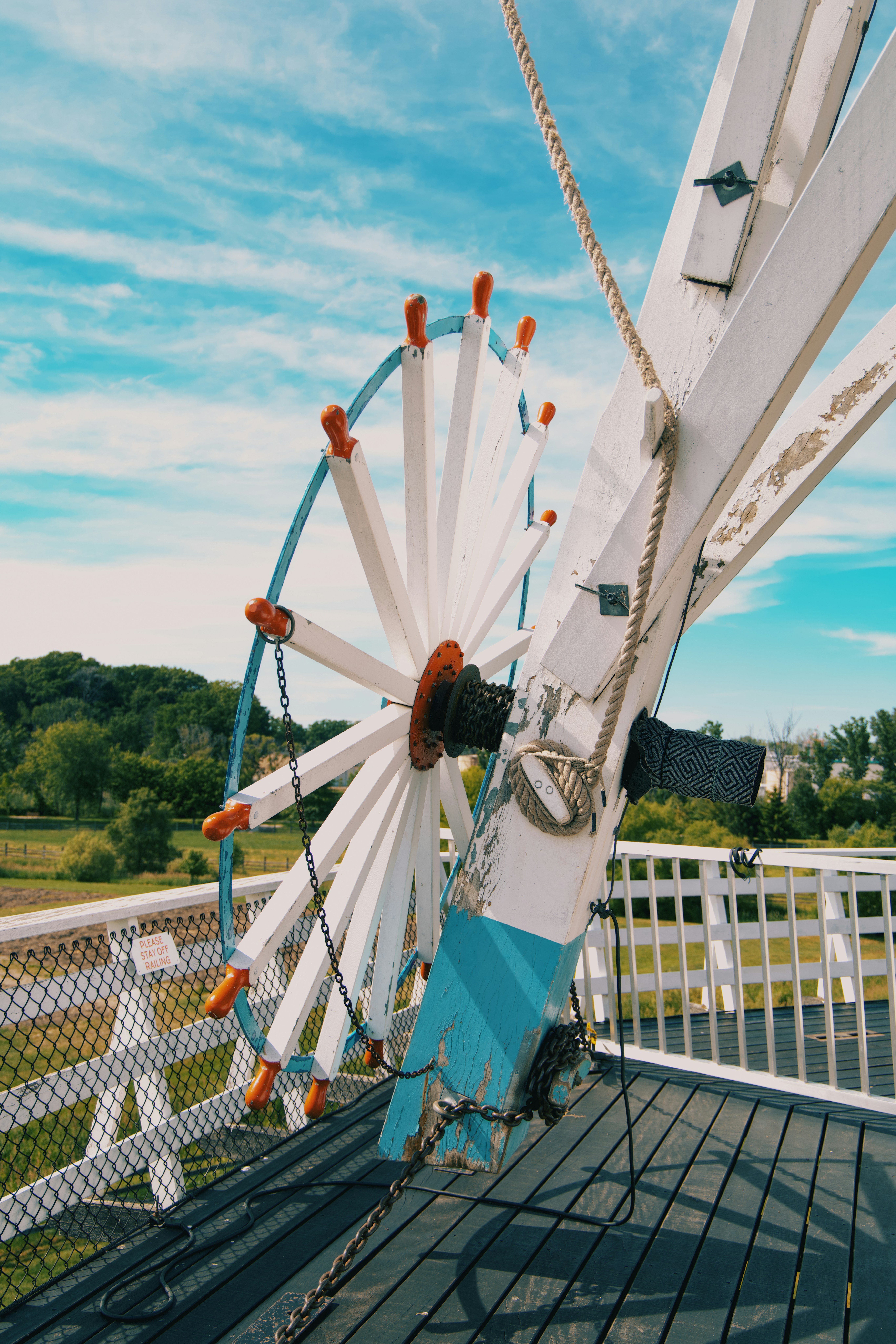 Sailing Wheel on a Tilt: Rosette Spokes against a Bright Sky