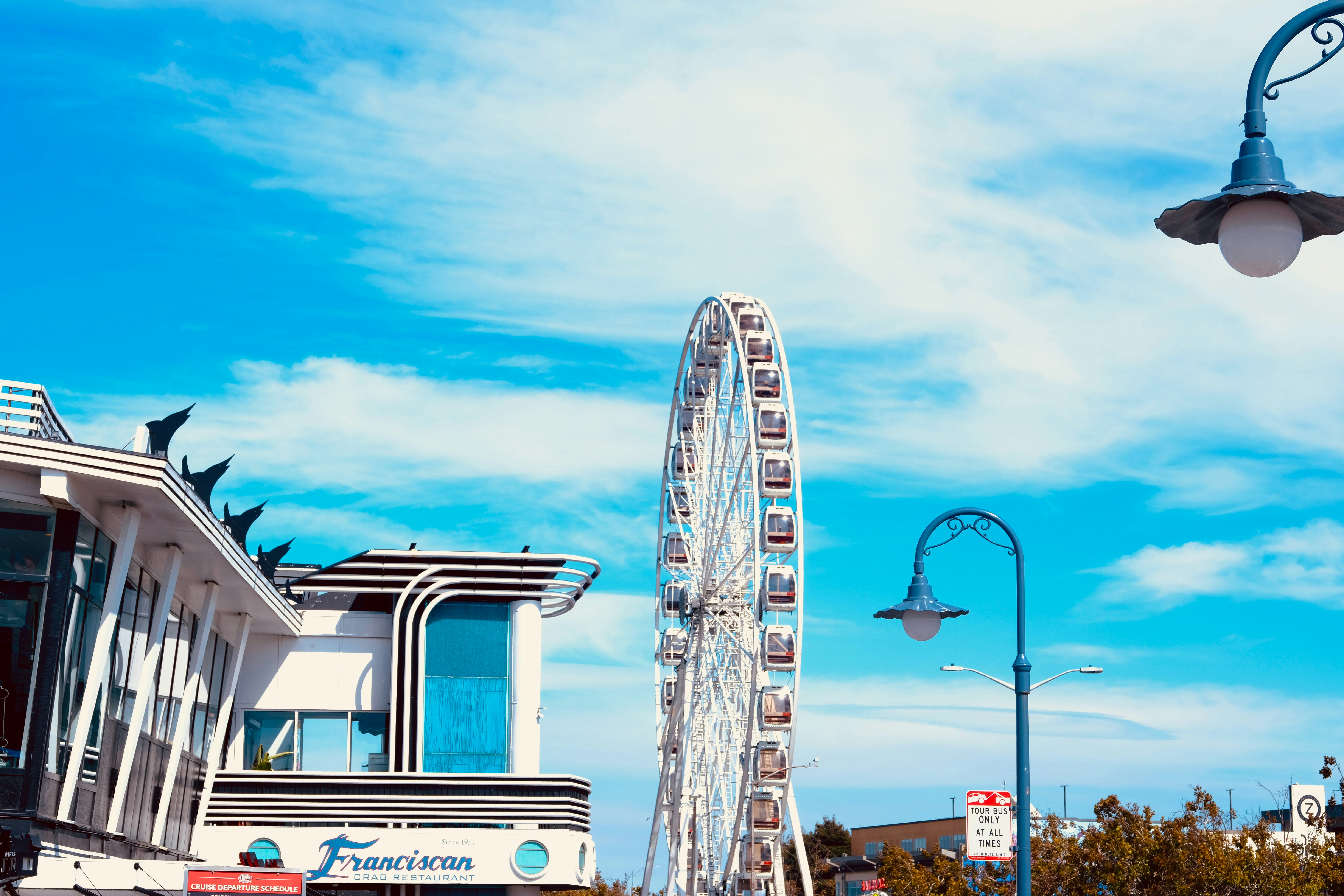 City ferris wheel rising over a seaside arcade