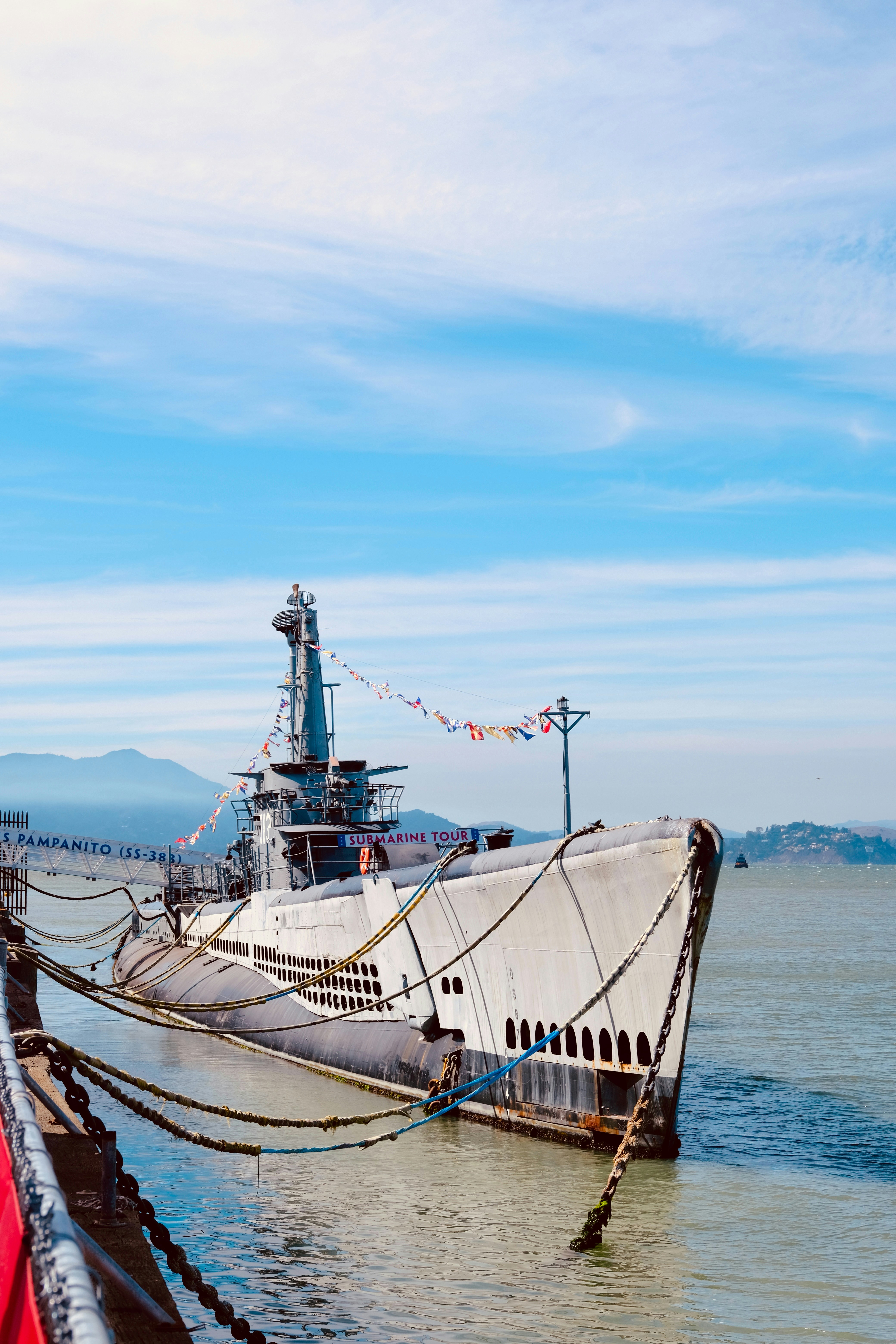 Bowline and Ocean: A Distant Vessel Anchored in Calm Blues
