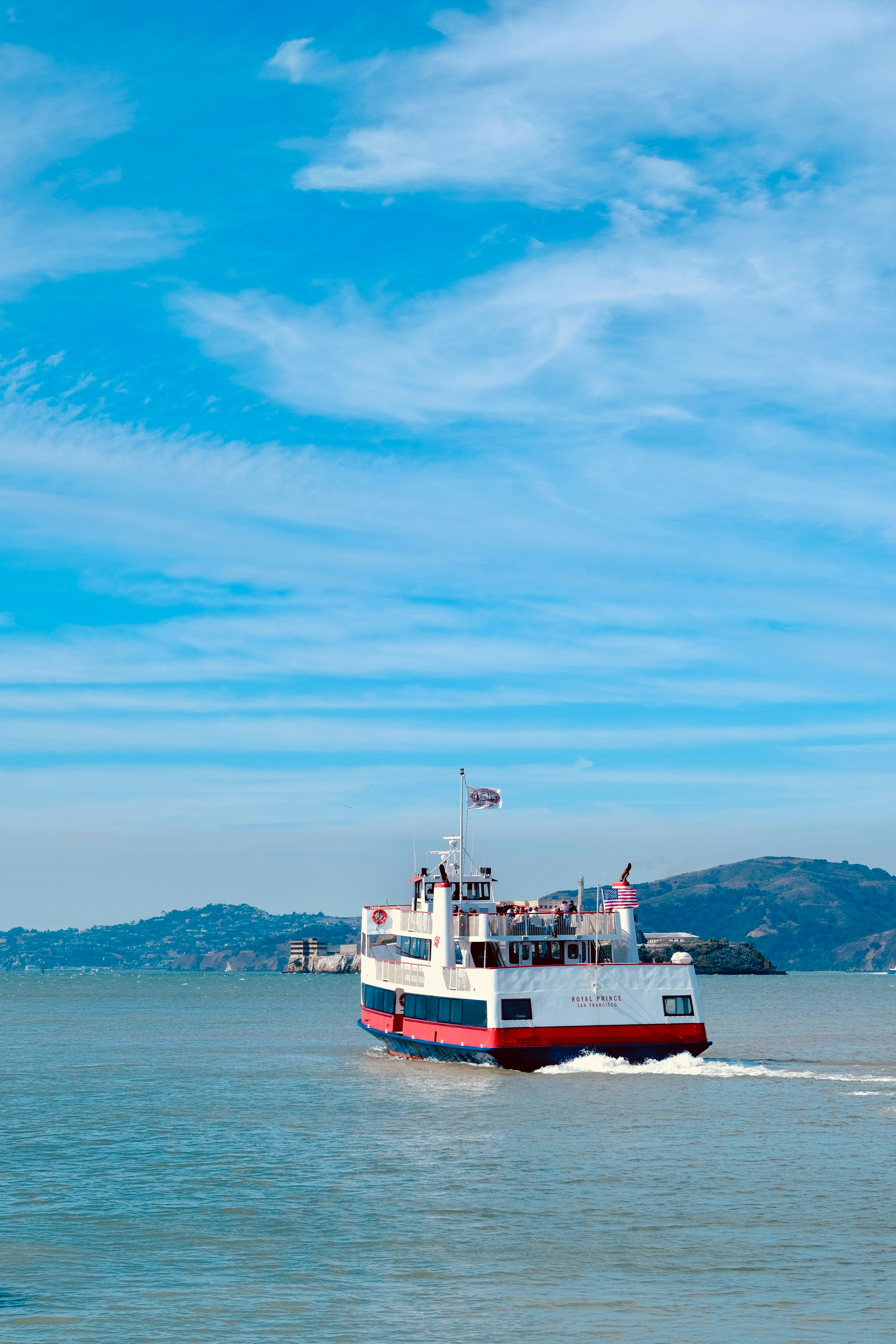 Passenger Ferry carving a wake across calm blue waters