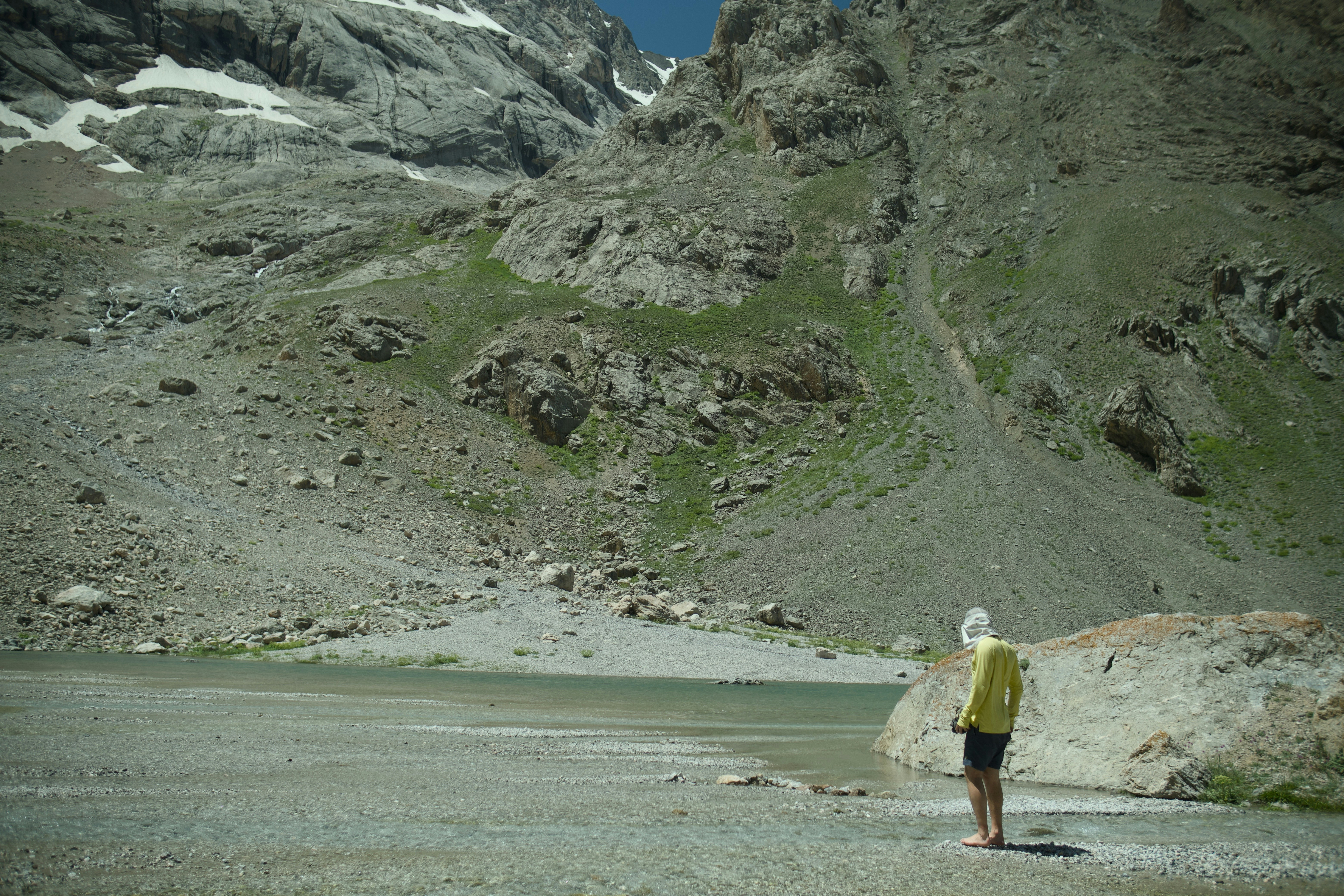 Alpine Refuge: A lone hiker at the edge of a glacial pool