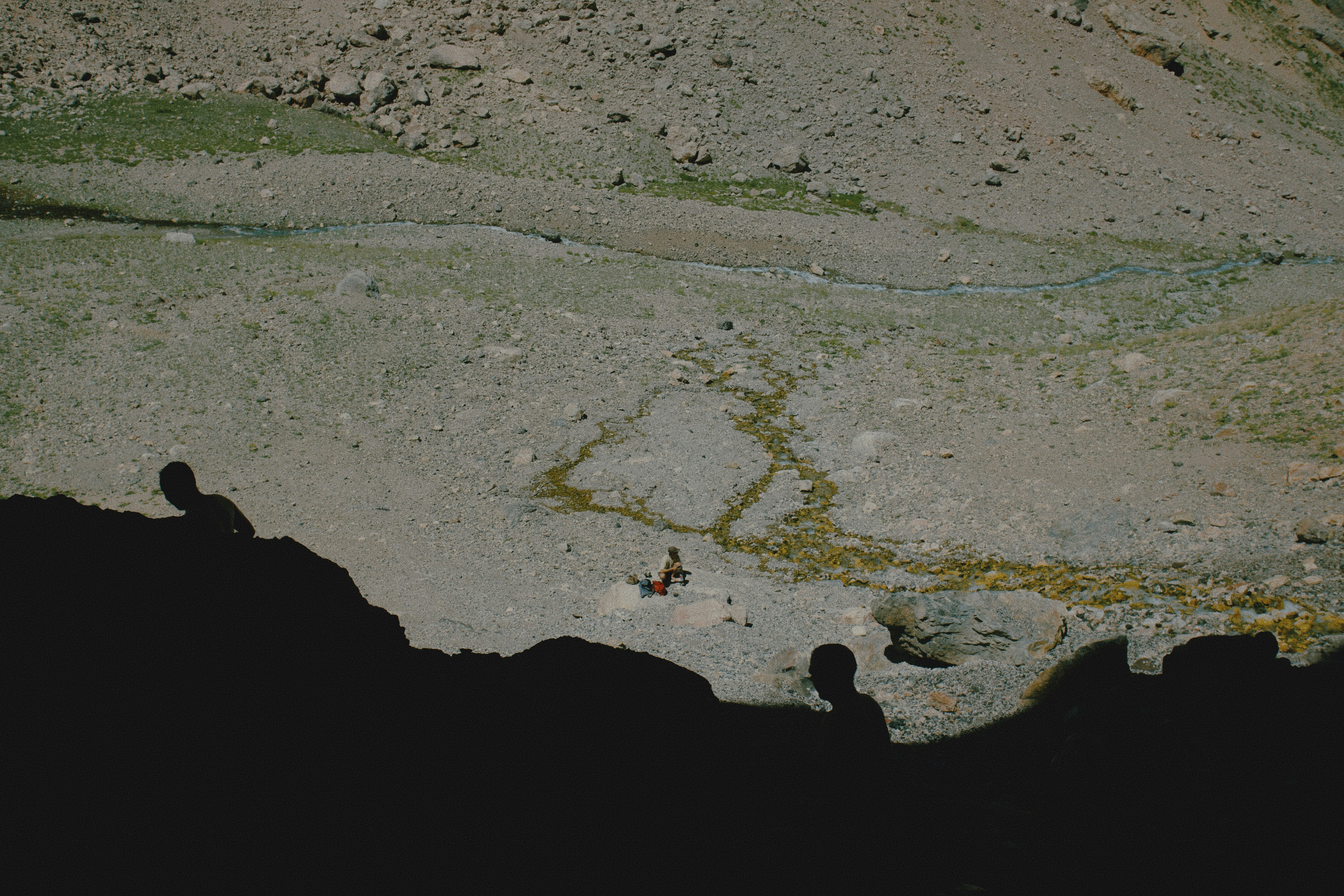 Hidden figures along a shaded shoreline