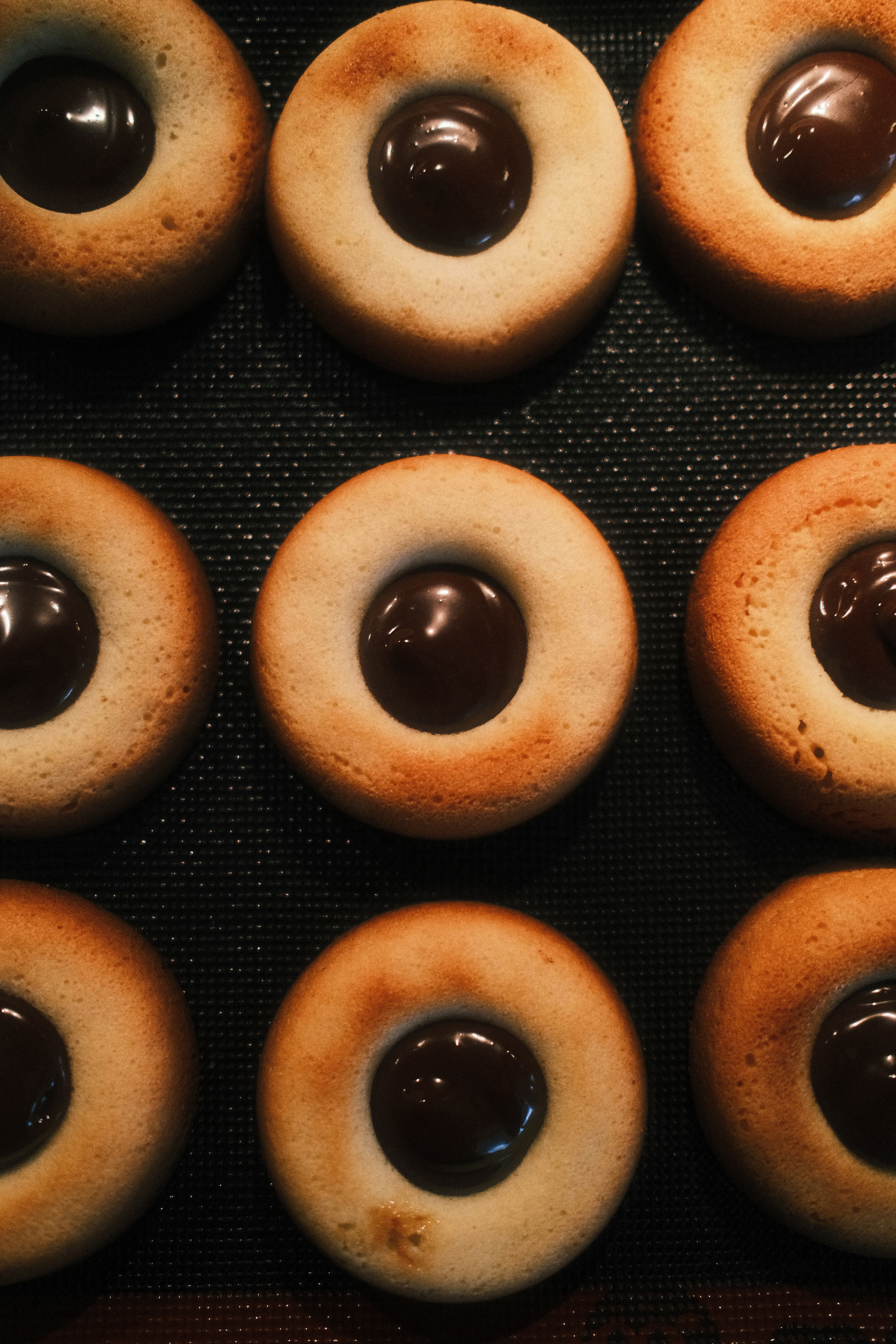 Chocolate-Dilled Samoas: A Row of Golden Ring Cookies with Center-Dilled Cores