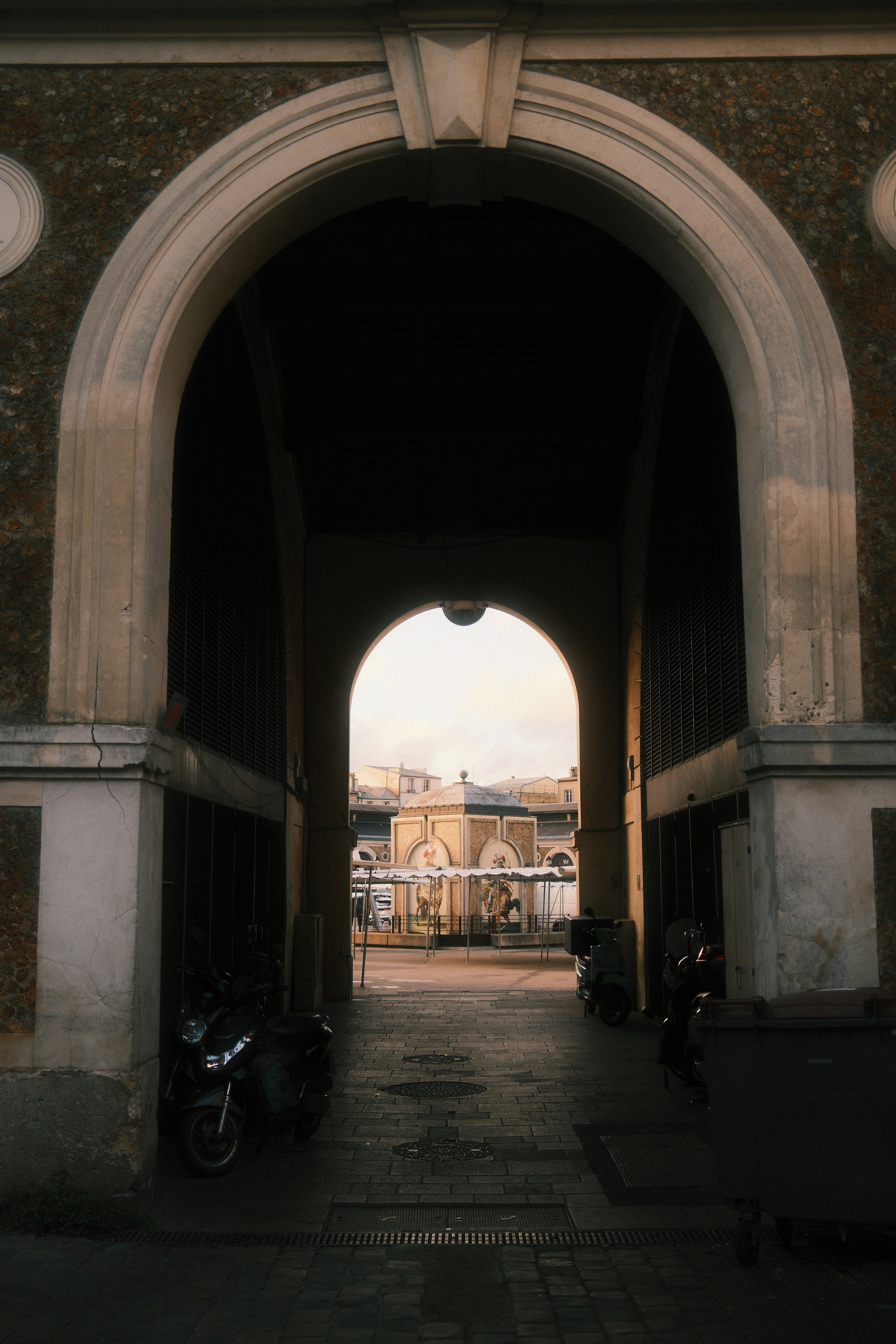 Archway to Light: A Quiet Street Beyond the Gate