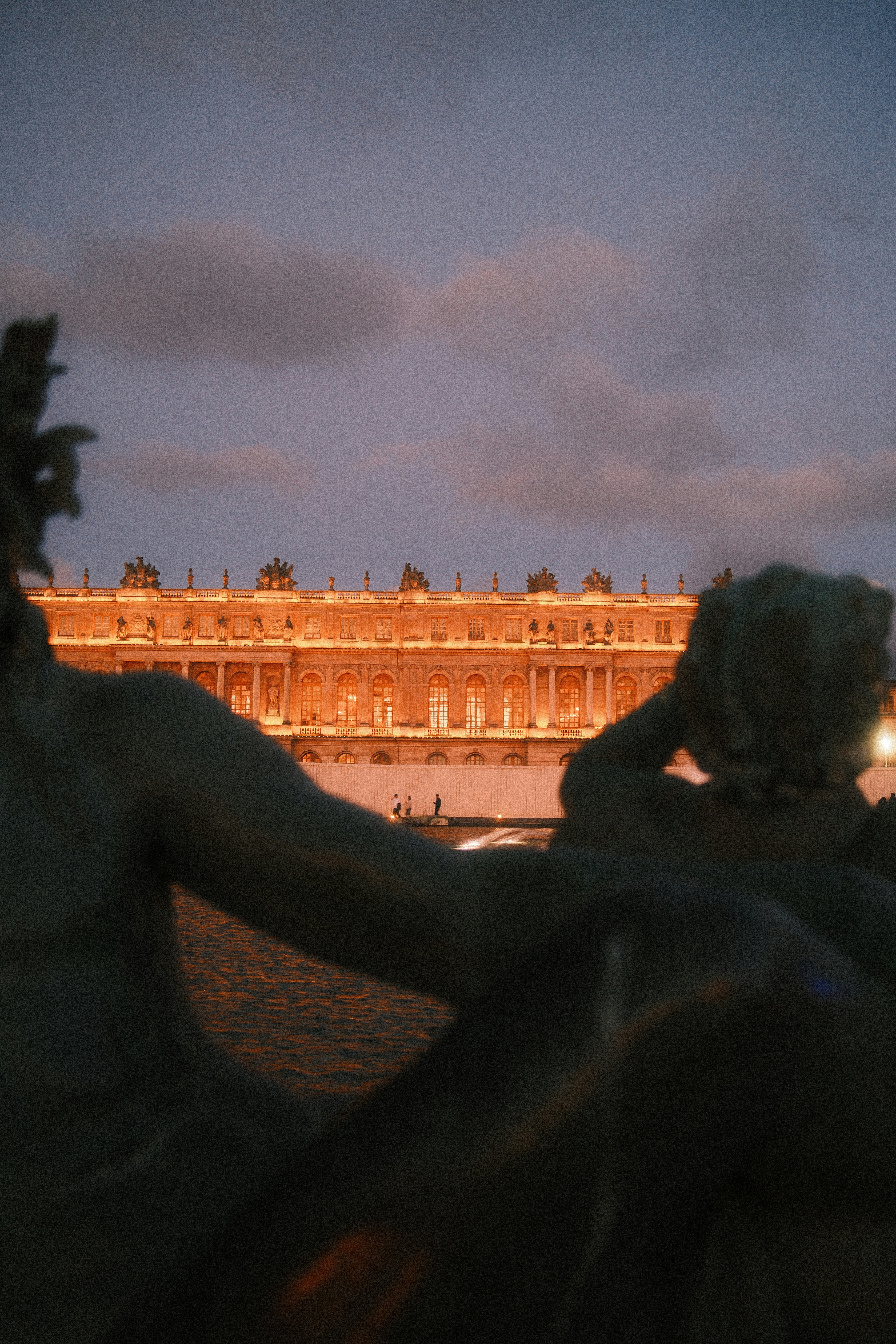 Moonlit Courtyard Echoes: Sculptures and Golden Facade