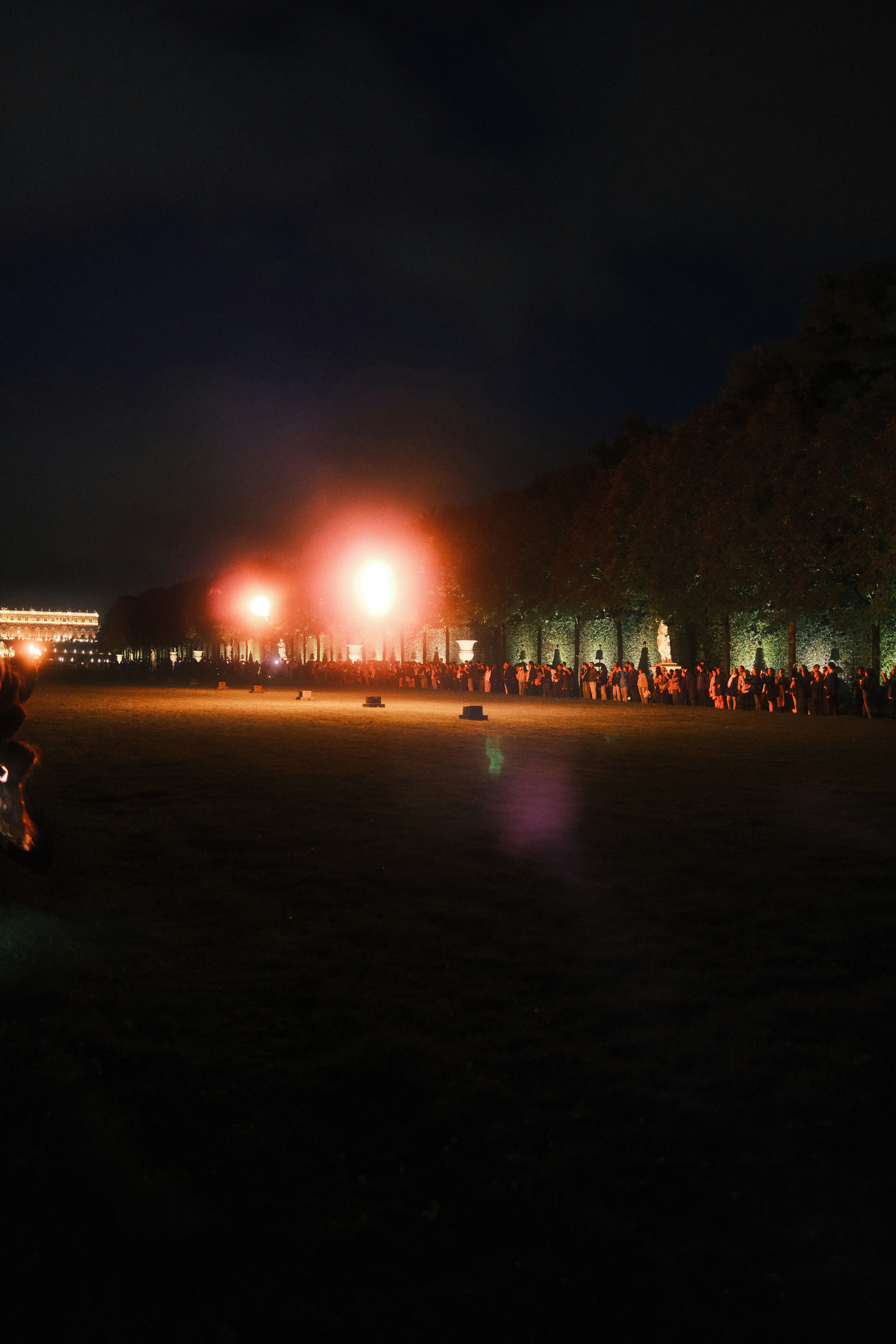 Night Parade Under Glowing Orbs Along the Park Line