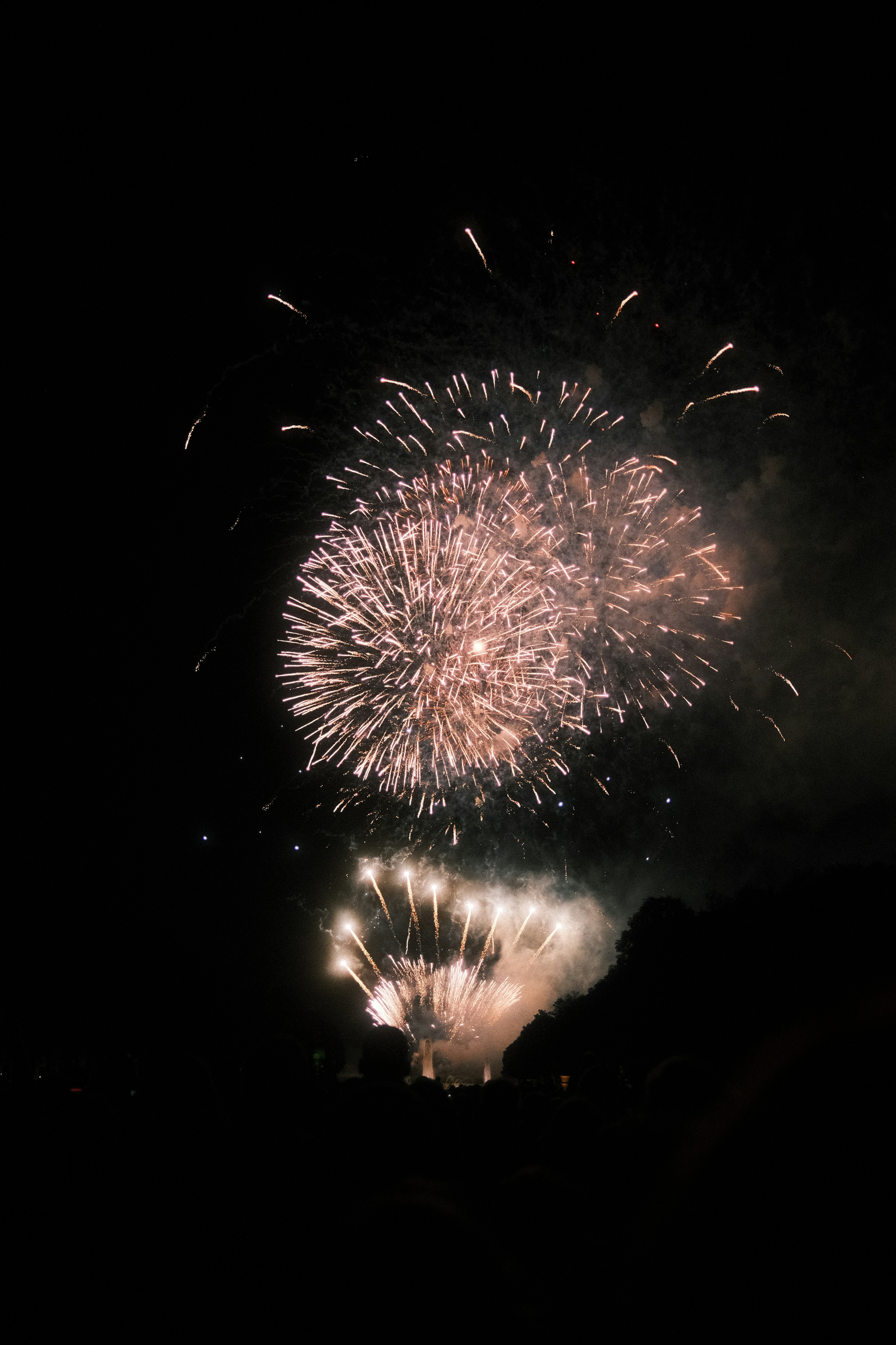 Night Sky Bursts: Fireworks Over a Silent Crowd