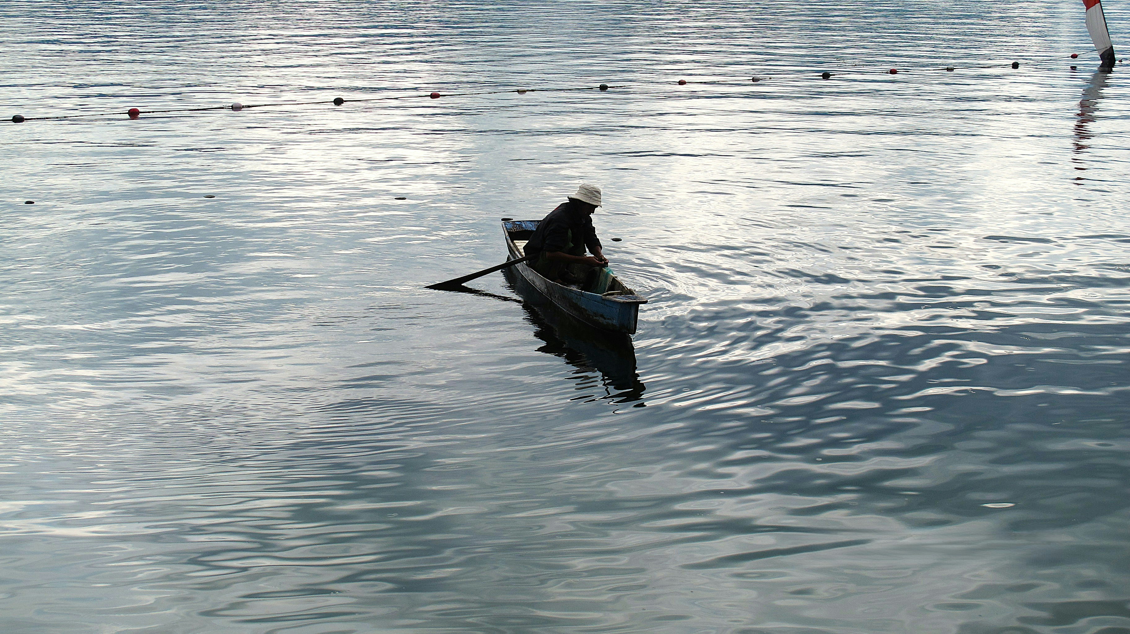 Lonely Rowboat on Quiet Harbor at Dusk