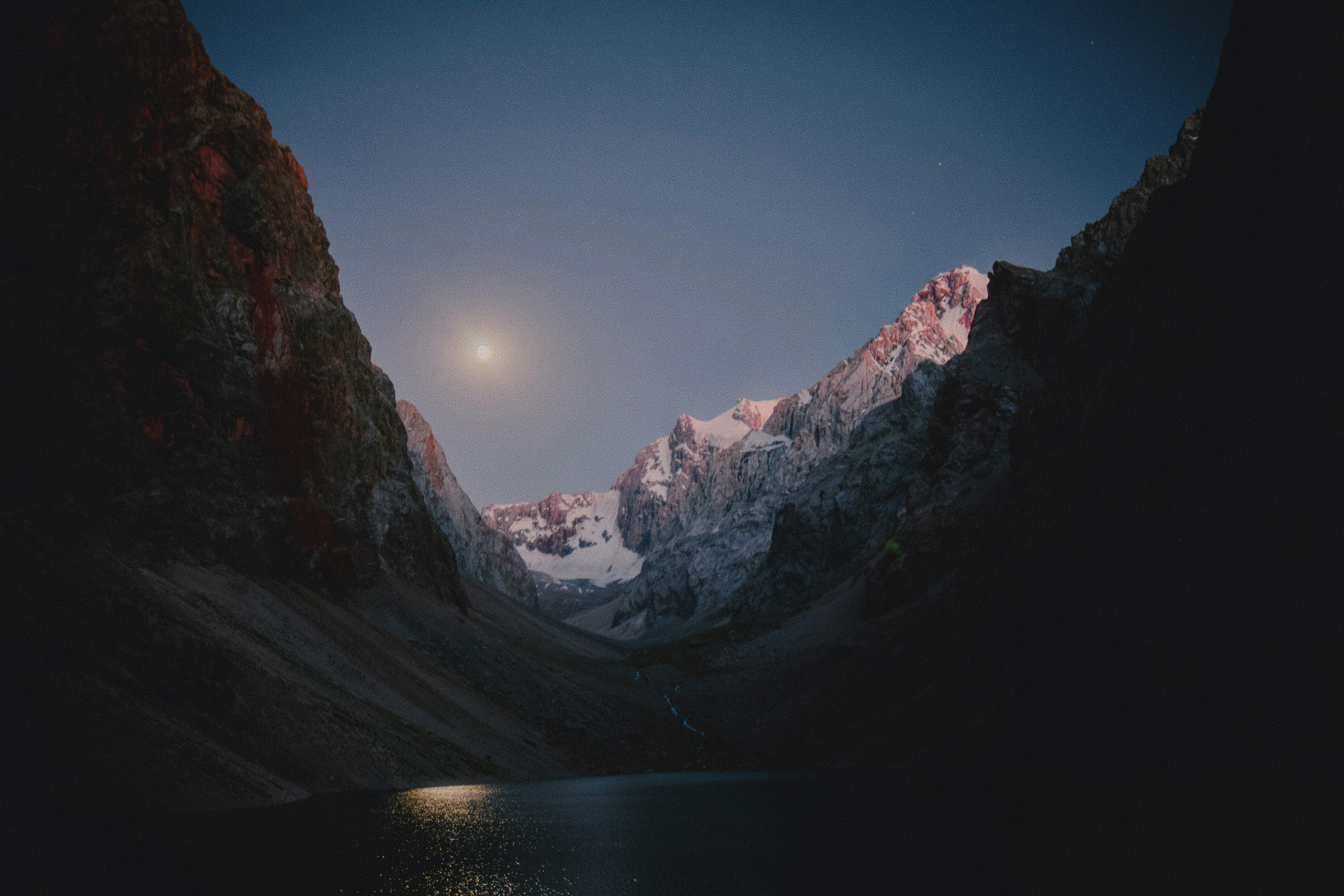 Moonlit Valley: Snow-Capped Peaks Under a Quiet Night