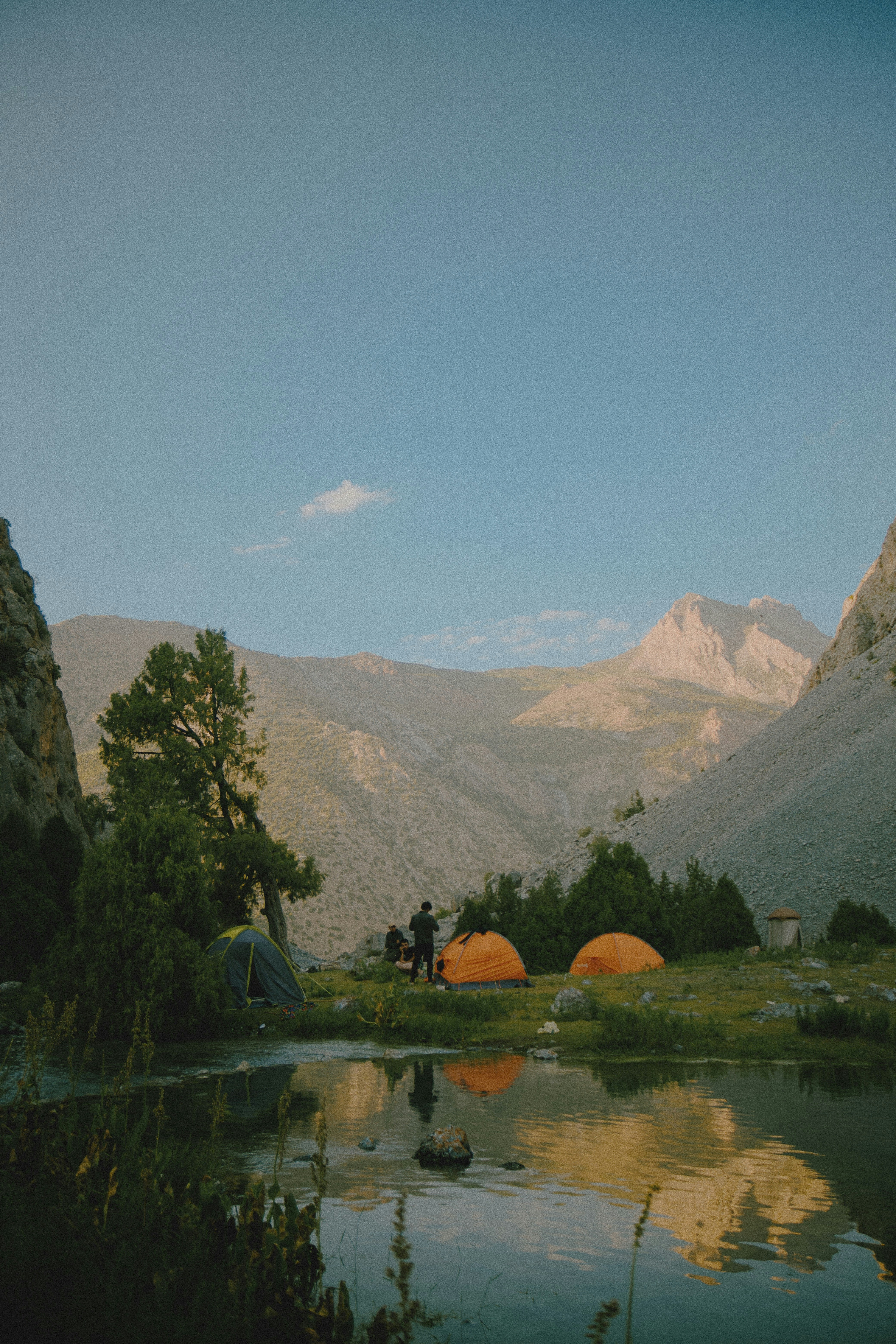 Twin Orange Tents at the Foot of a Rocky Valley