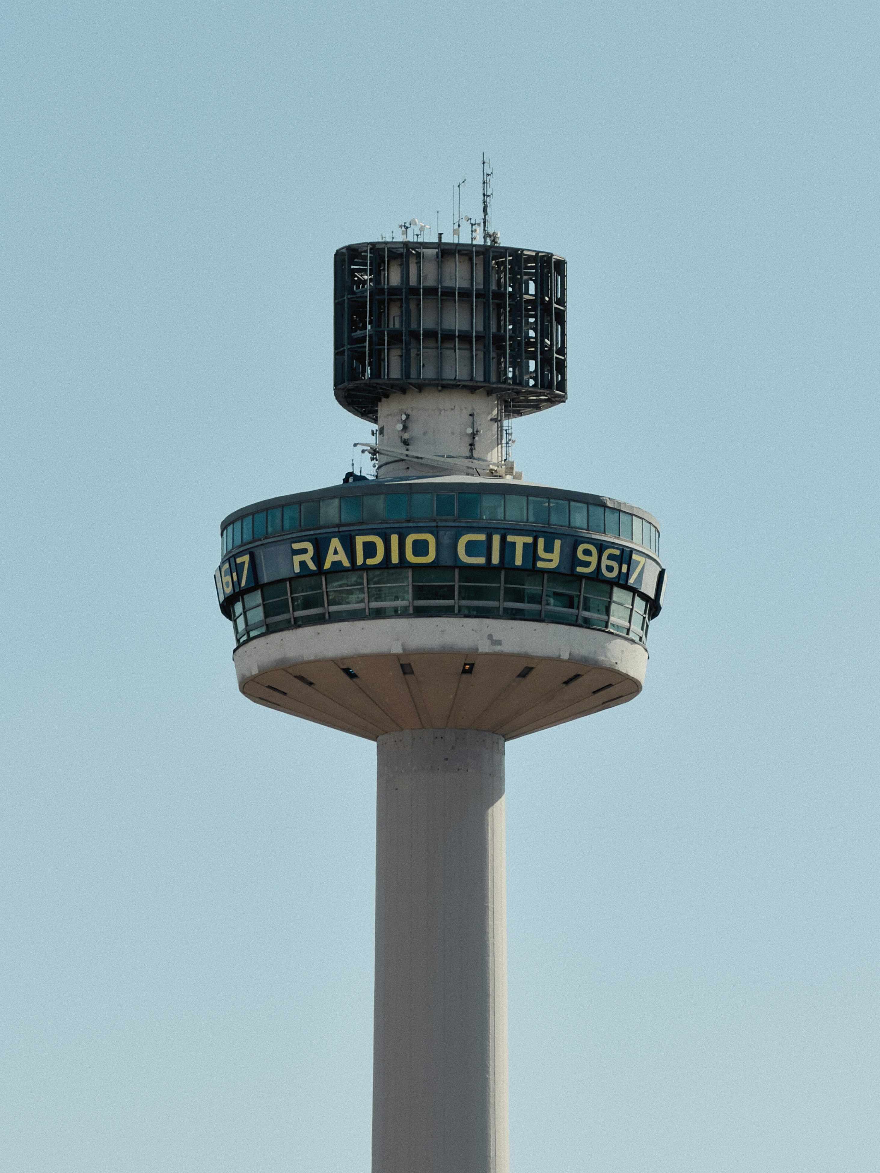 Radio City Overseer: A Towering Signpost Against a Clear Sky