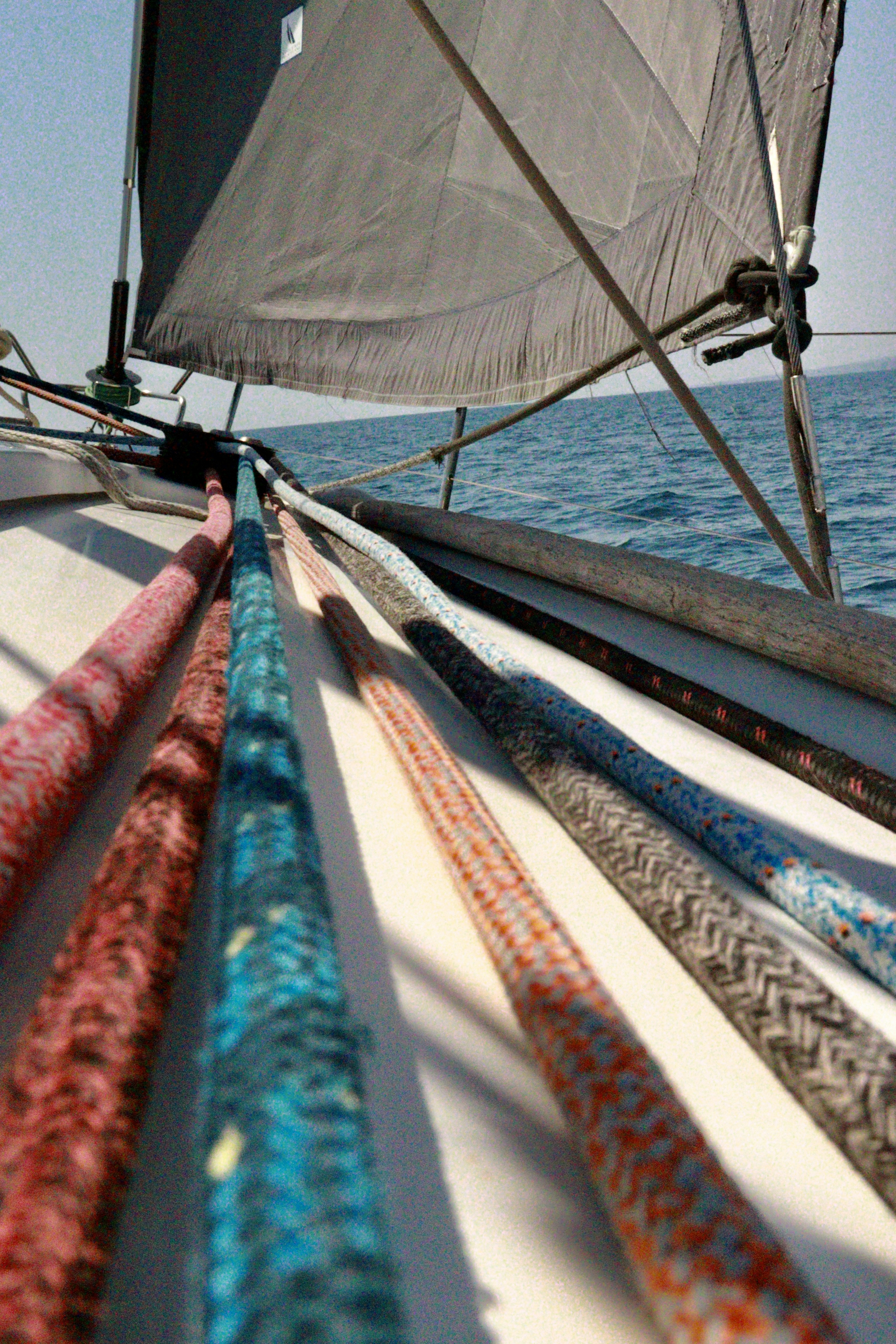 Ropes in Focus: A Sailboat’s Corded Path Across the Sea