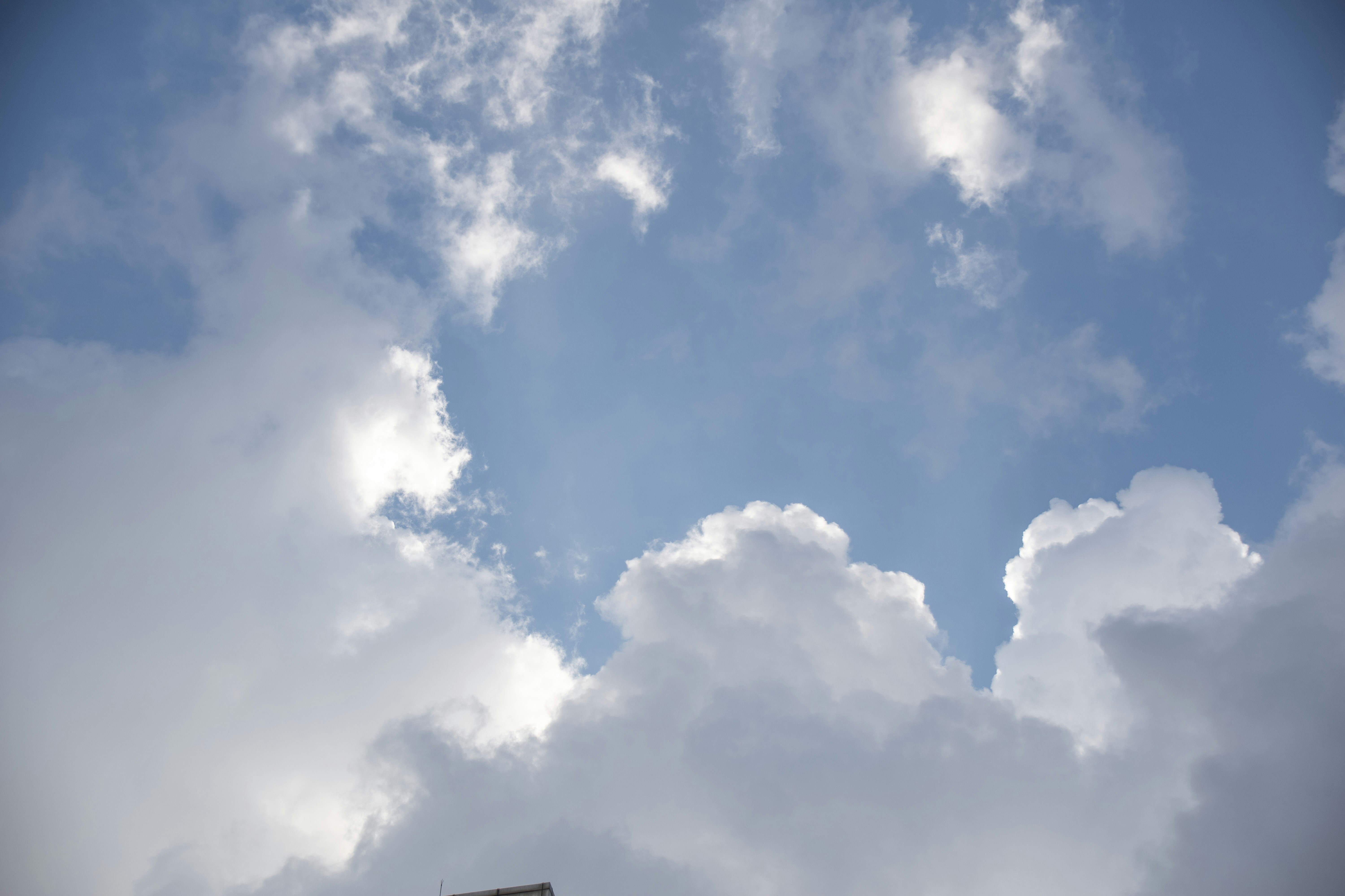 Skybound Whispers: Sunlit Clouds Quietly Unfold
