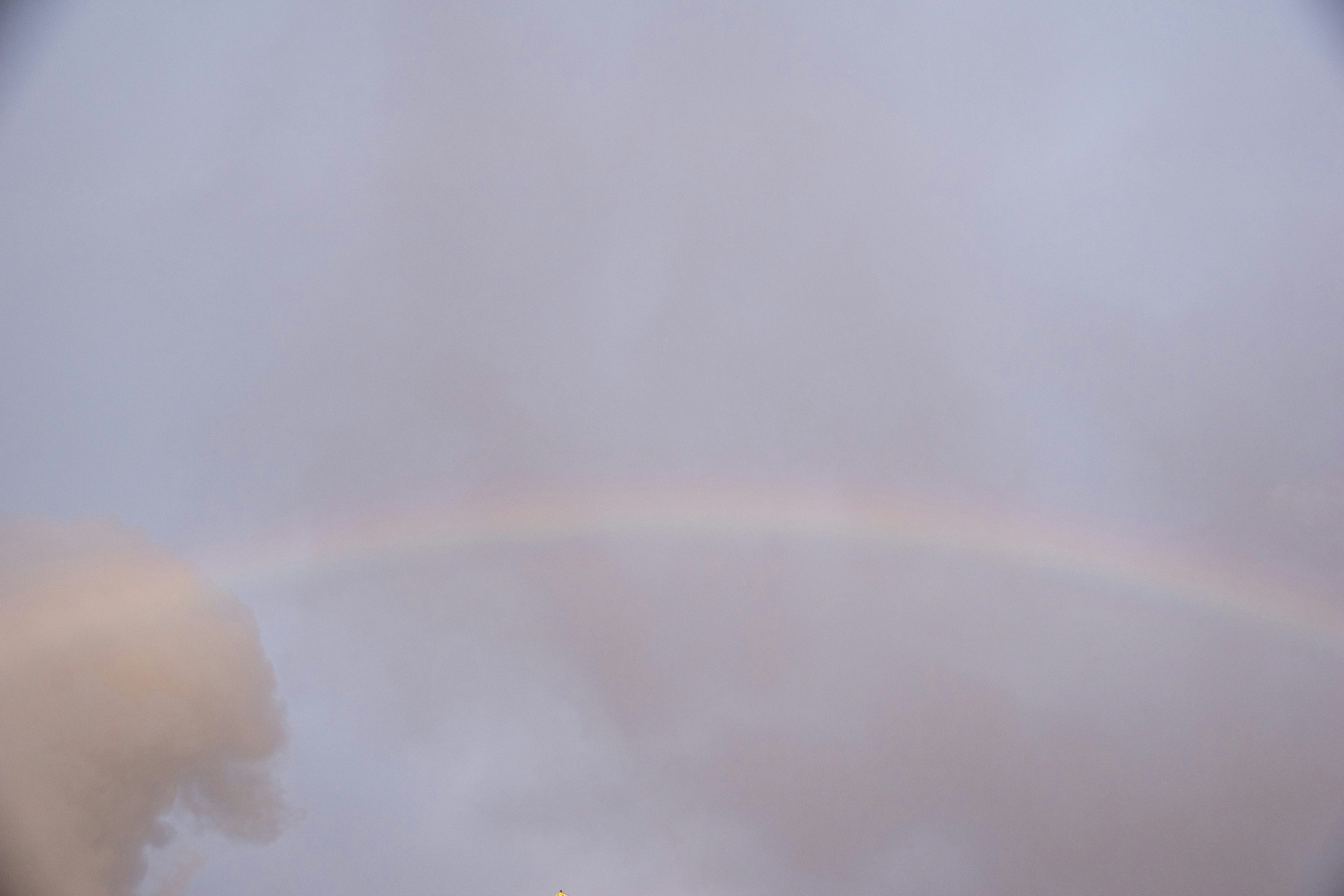 Ephemeral Arc: a Soft Rainbow Crossing a Gently Lit Sky