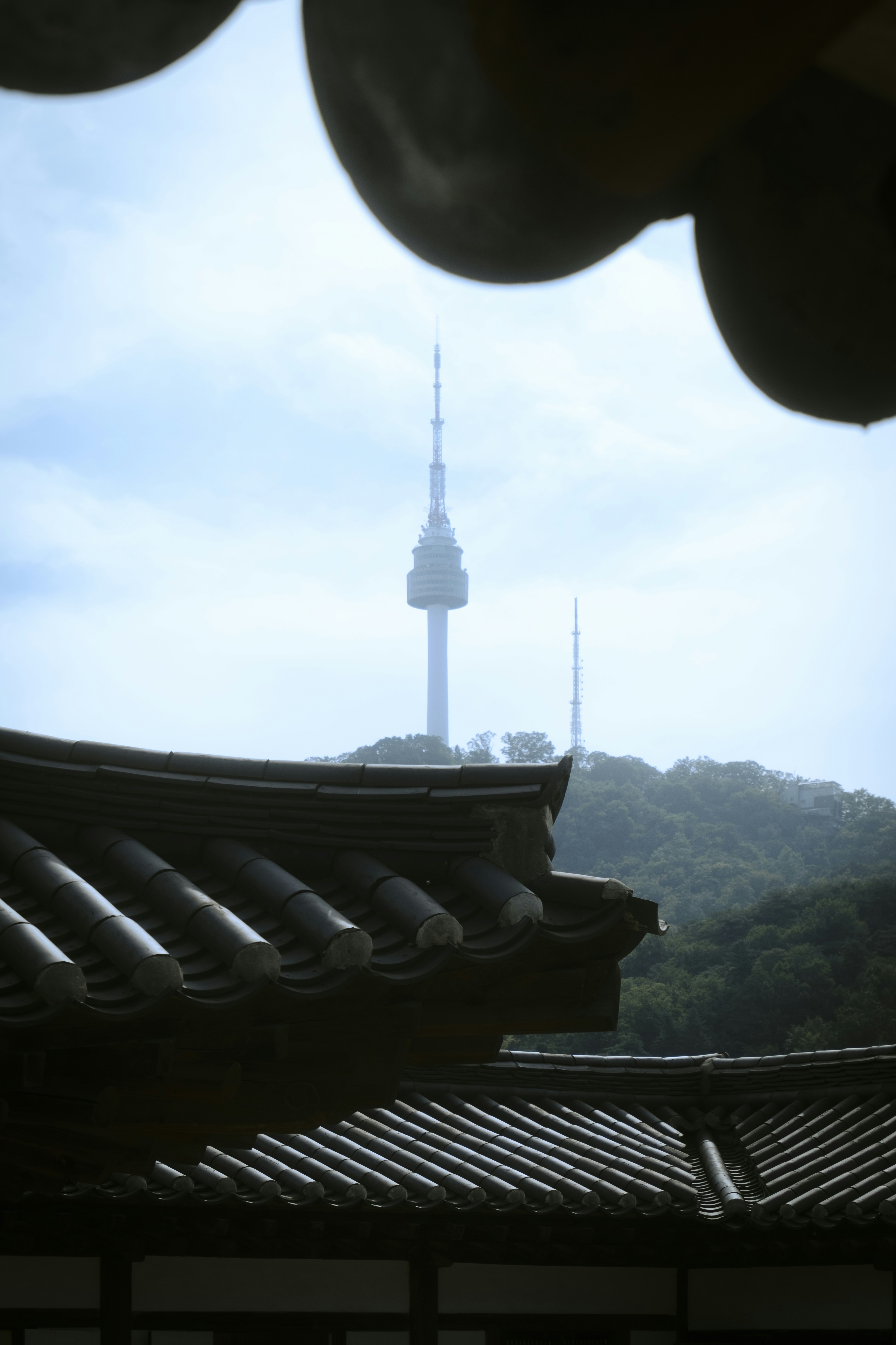 Urban Silhouette: A Towered Horizon Above Rooftiled Shadows