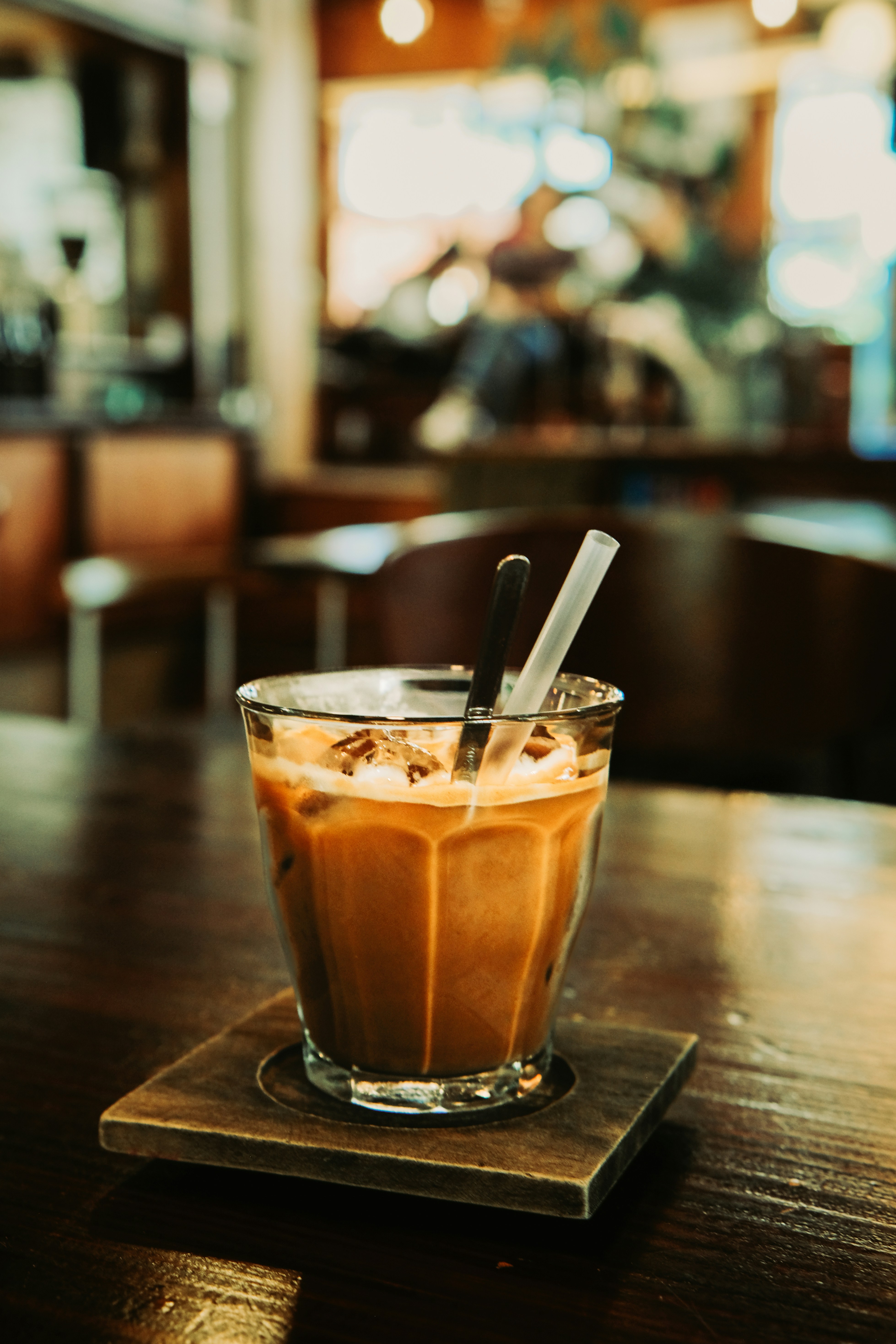 Amber Twilight: A Glass of Iced Coffee on a Quiet Bar Counter
