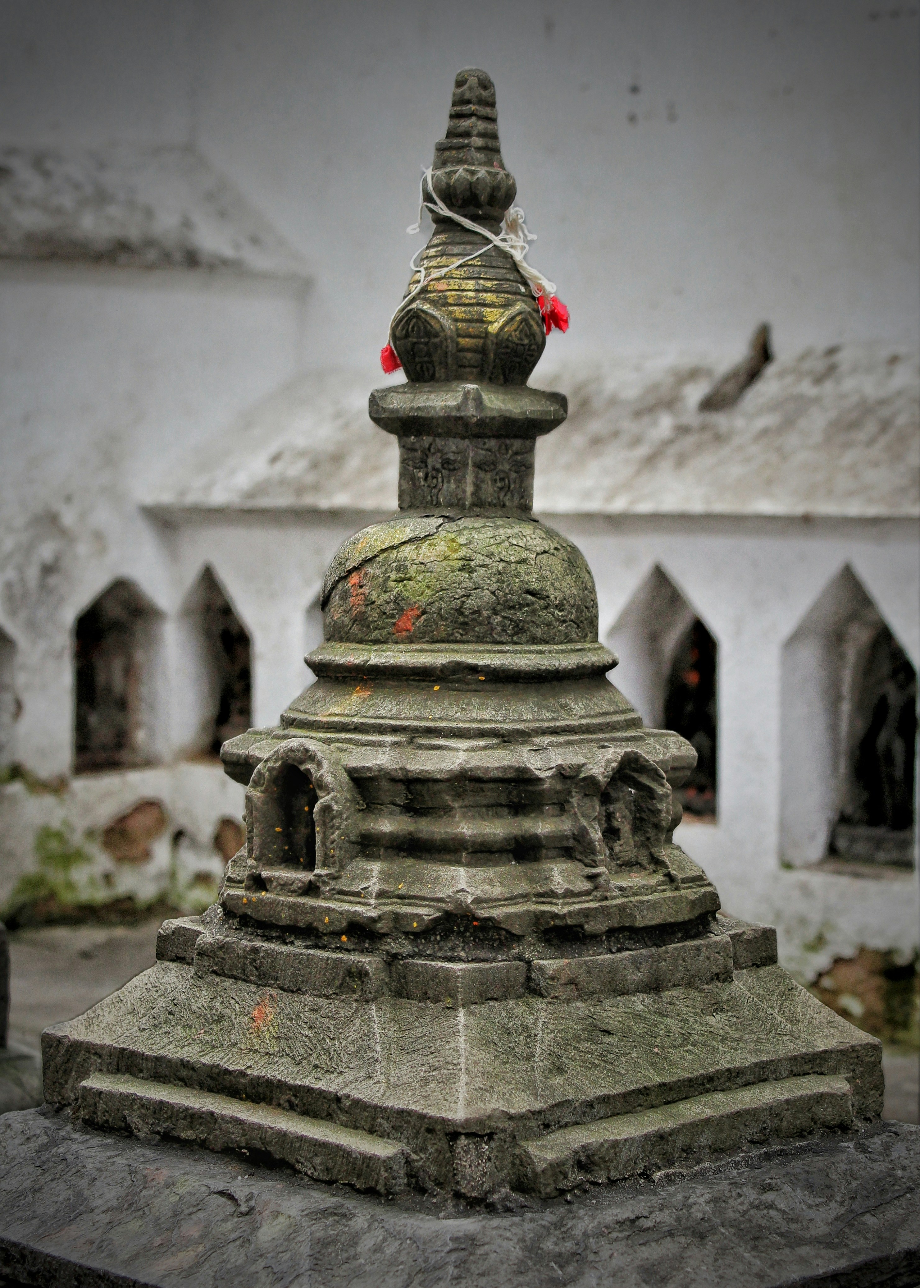 Weathered Shikhara Lantern: A Moss-Capped Cenotaph in Quiet Decay
