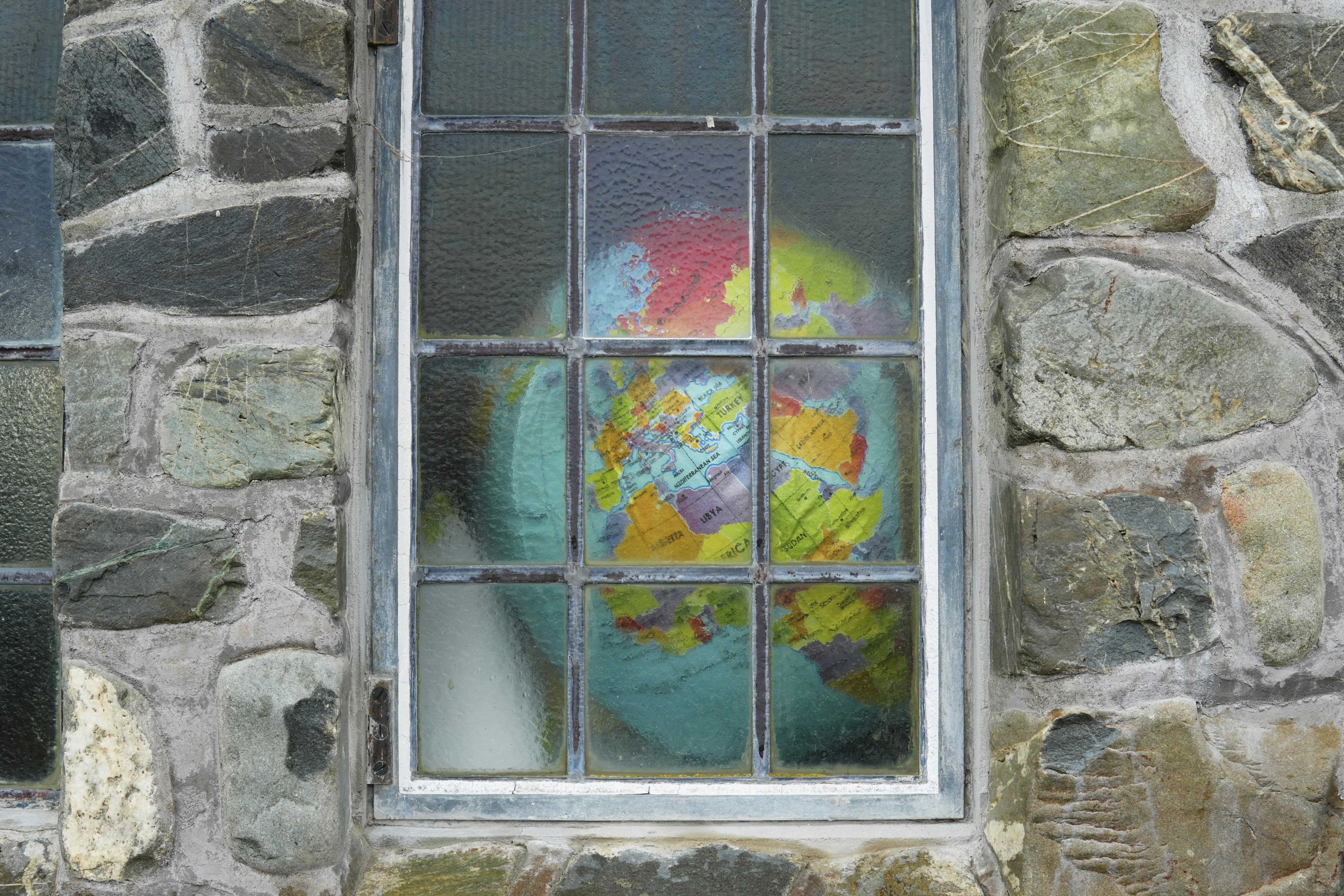 Globe Behind Glass: A World Within a Stone Window