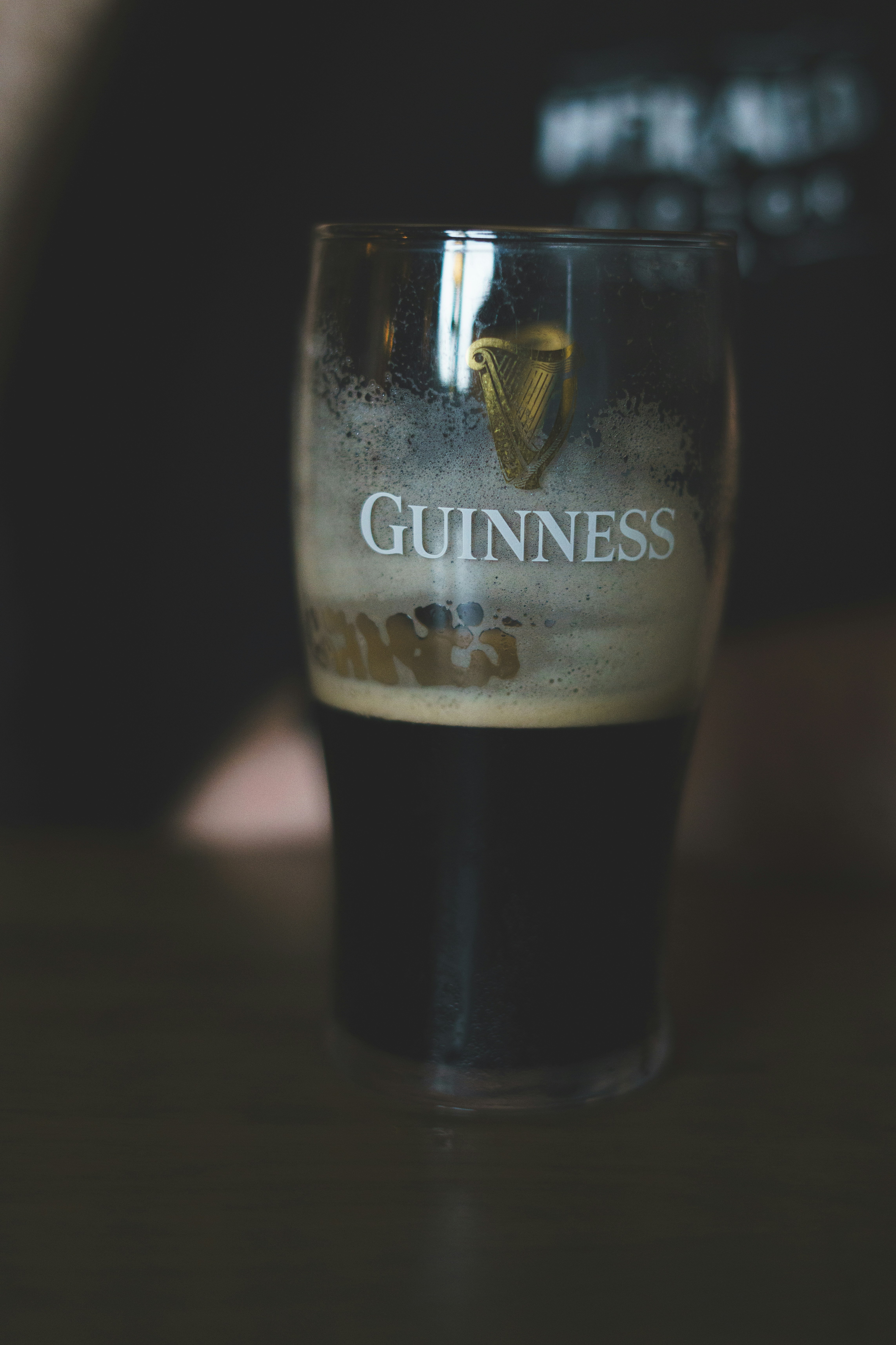 Guinness Glass in the Spotlight: A Silhouette of Velvet Night