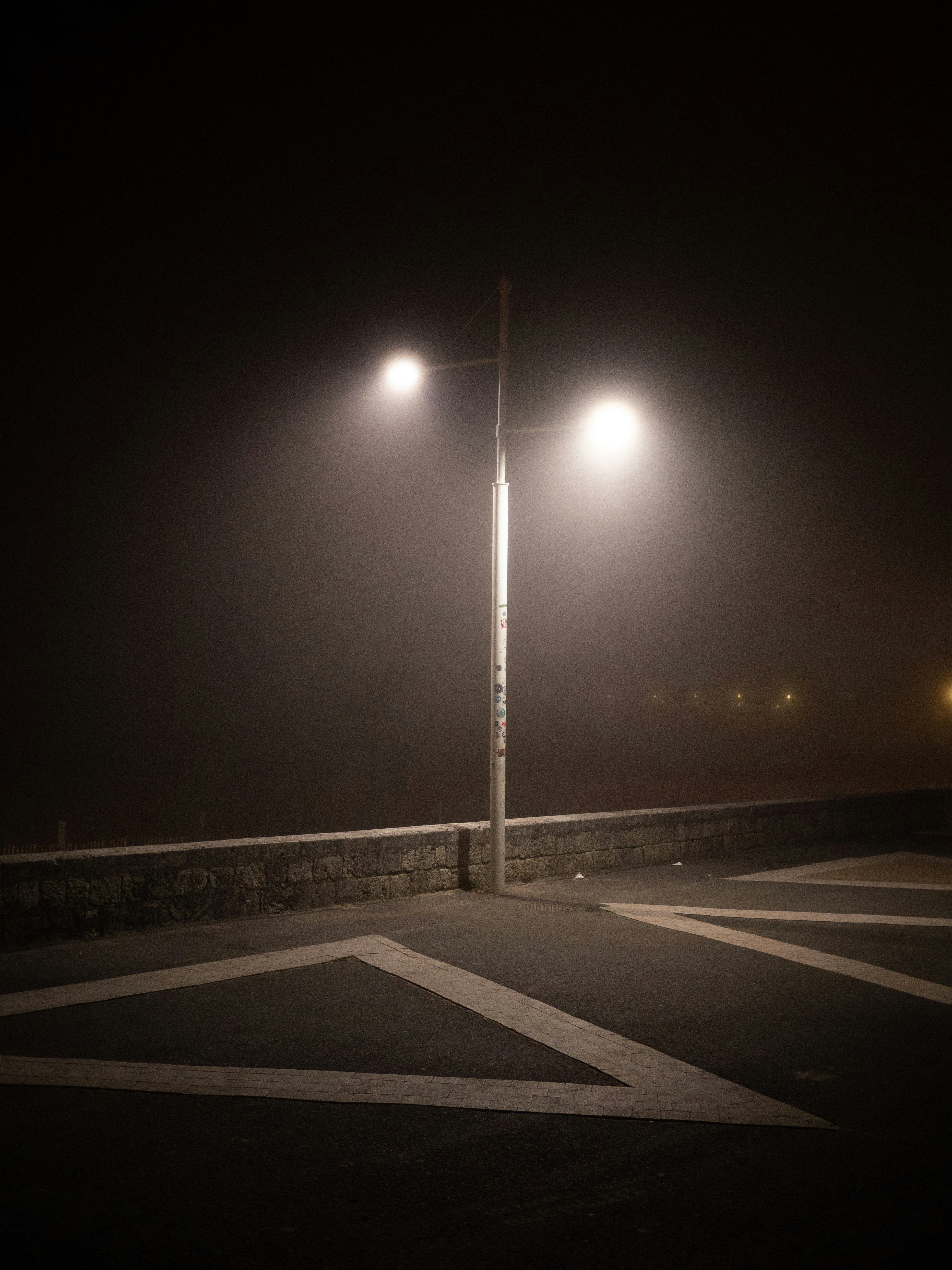 Mist over the Pier: A Quiet Night Under Twin Street Lamps