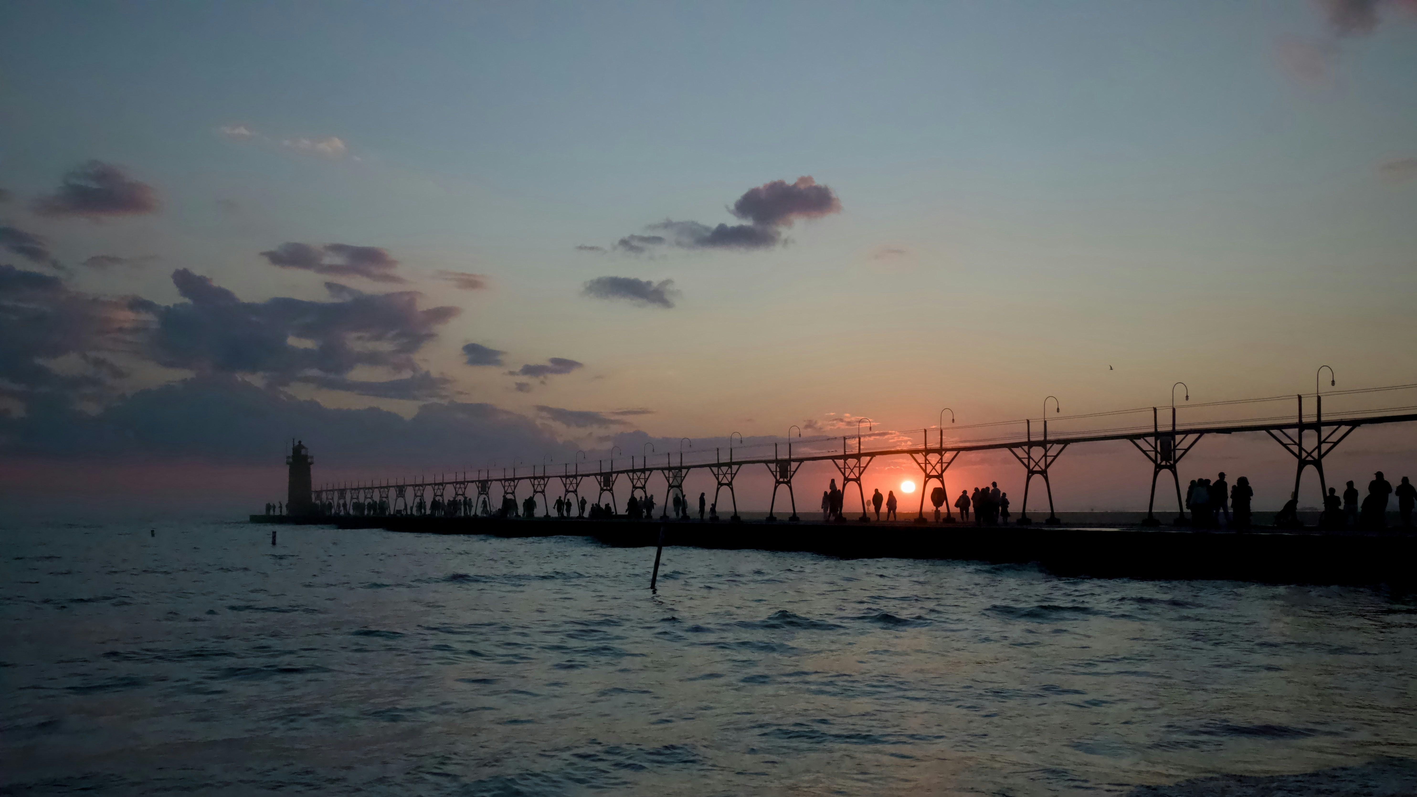 Sunlit Pier at Dusk: Silhouettes on the Twilight Causeway