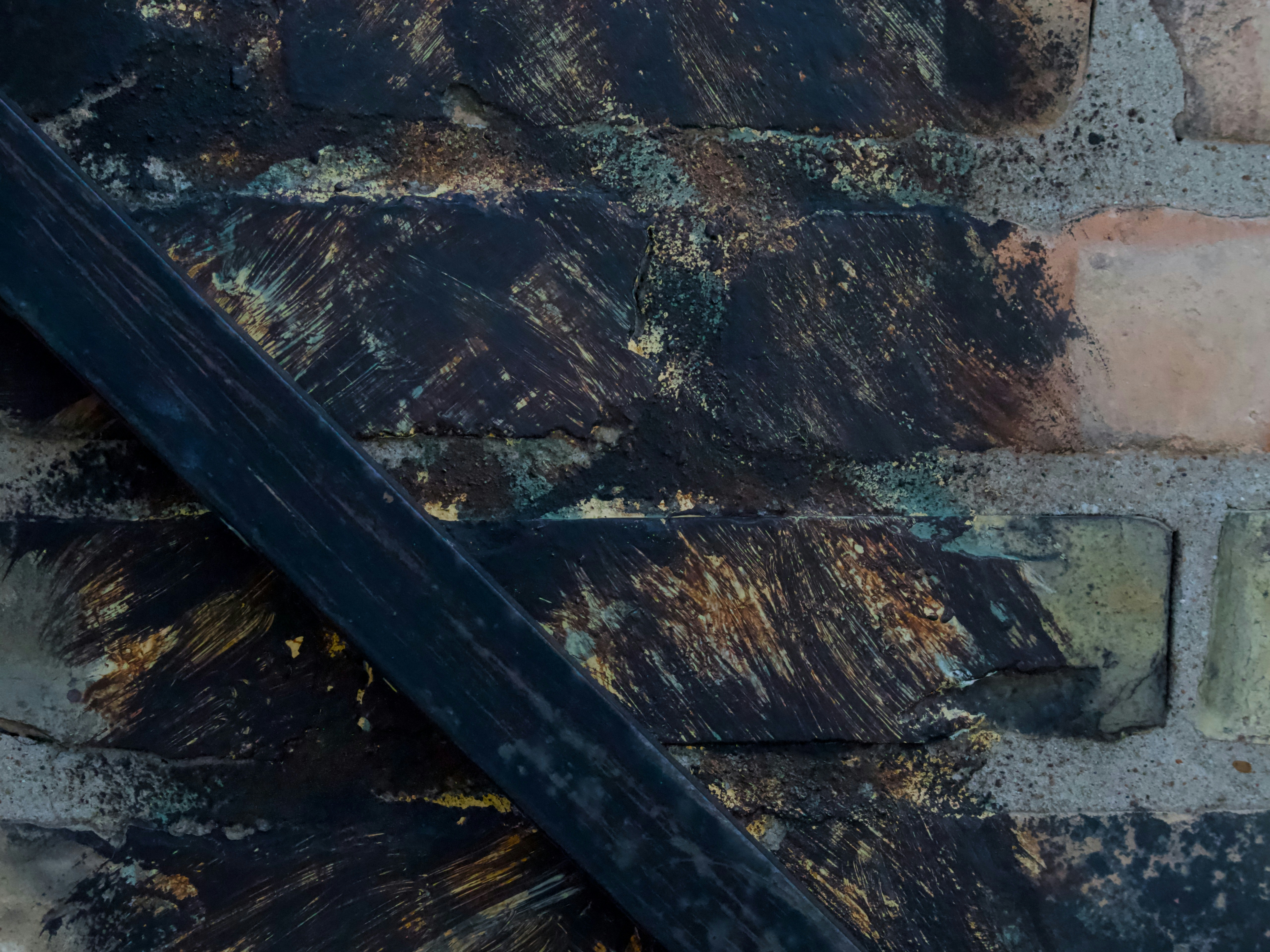Charred Sliver Across Weathered Brick