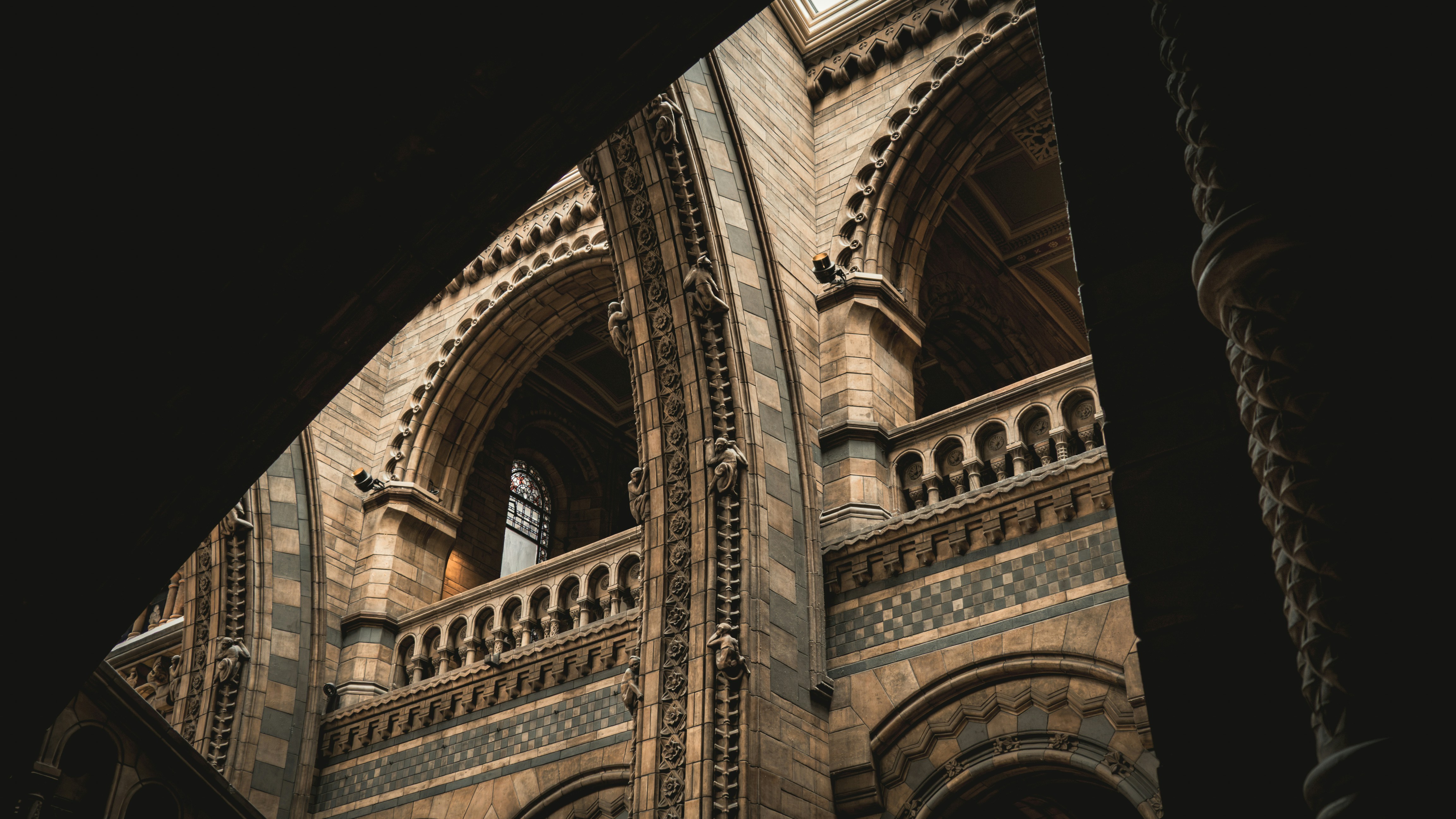 Archway Echoes: Carved Stone in a Dim Gallery