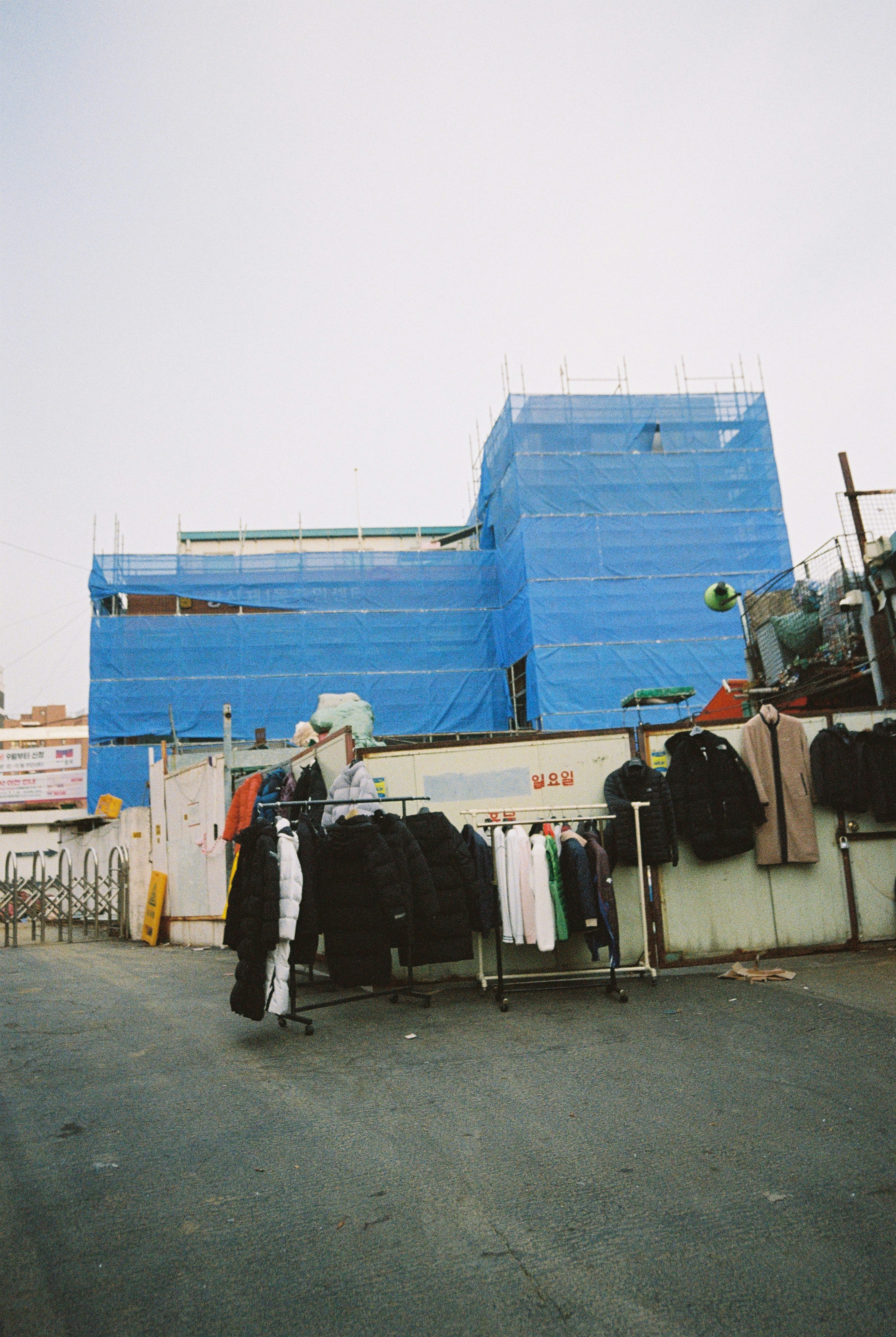 Blue Construction and Streetwear Stalls under Urban Scaffold
