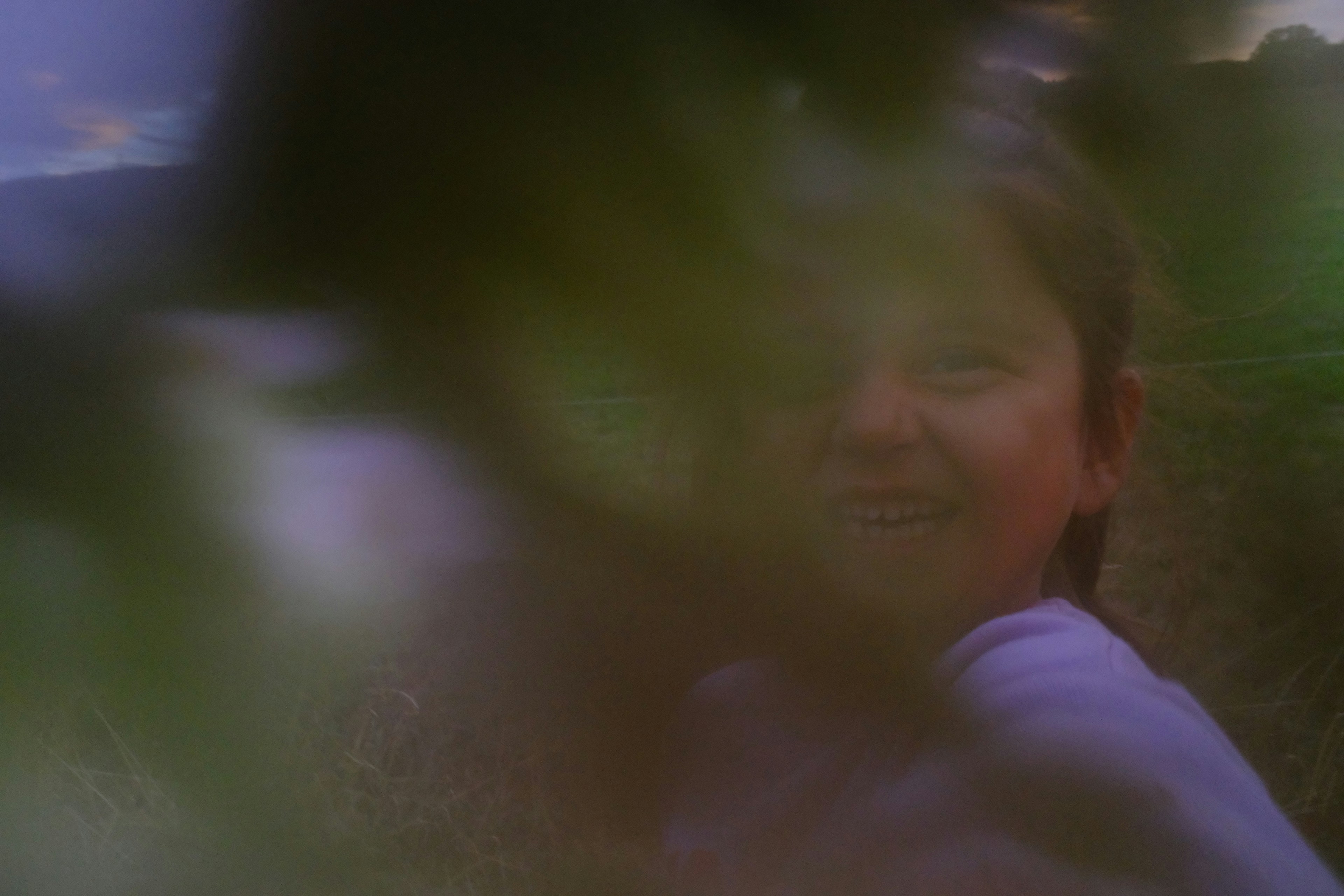 Soft Grin Through the Veil of Leaves