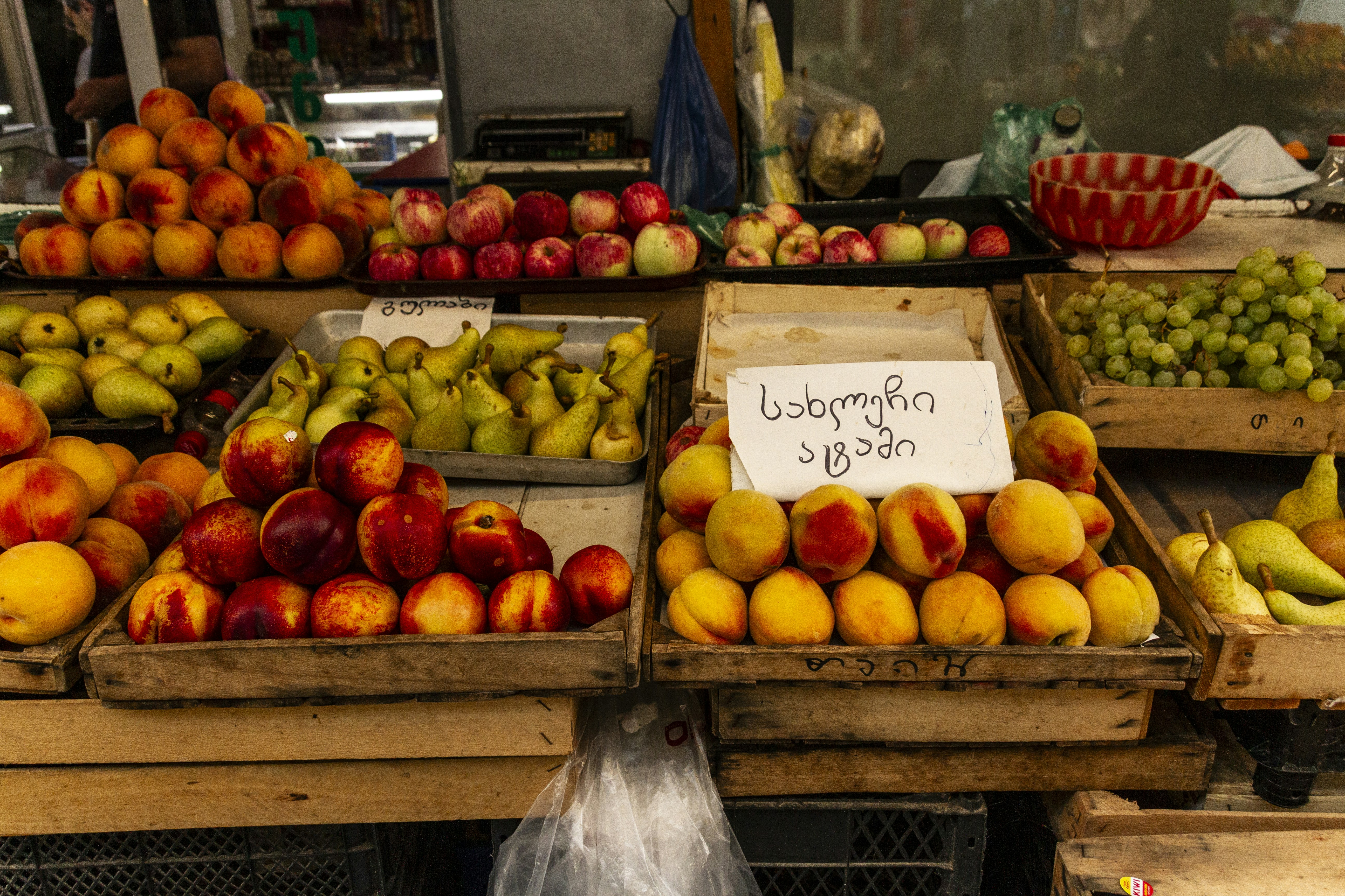 Colorful Market Bounty: Stacked Fruit Boxes at Dusk