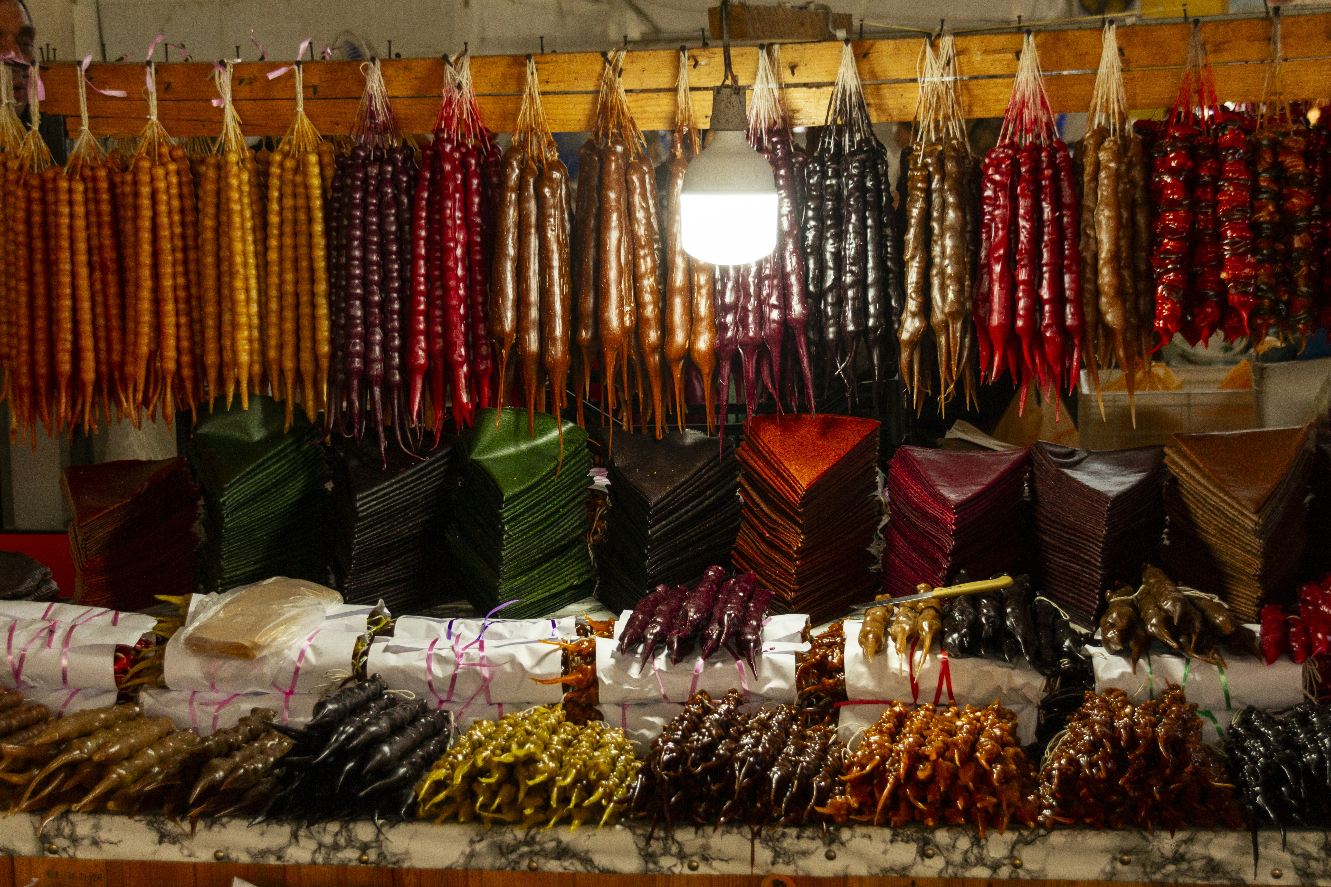 Amber Threads: A Market Stand of Hanging Spikes and Shiny Pelts